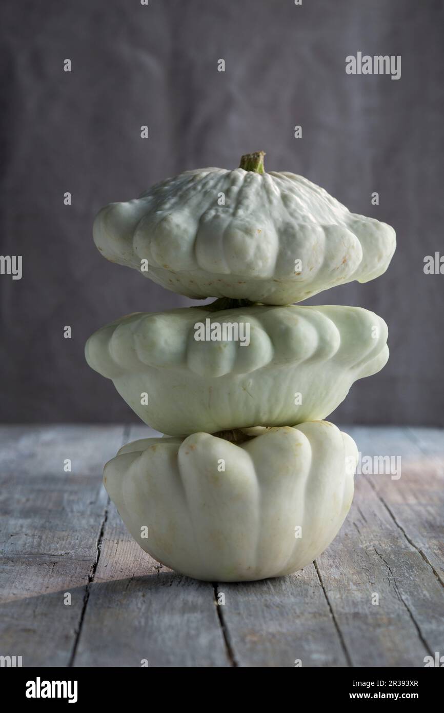 A stack of three patty-pan squash Stock Photo - Alamy