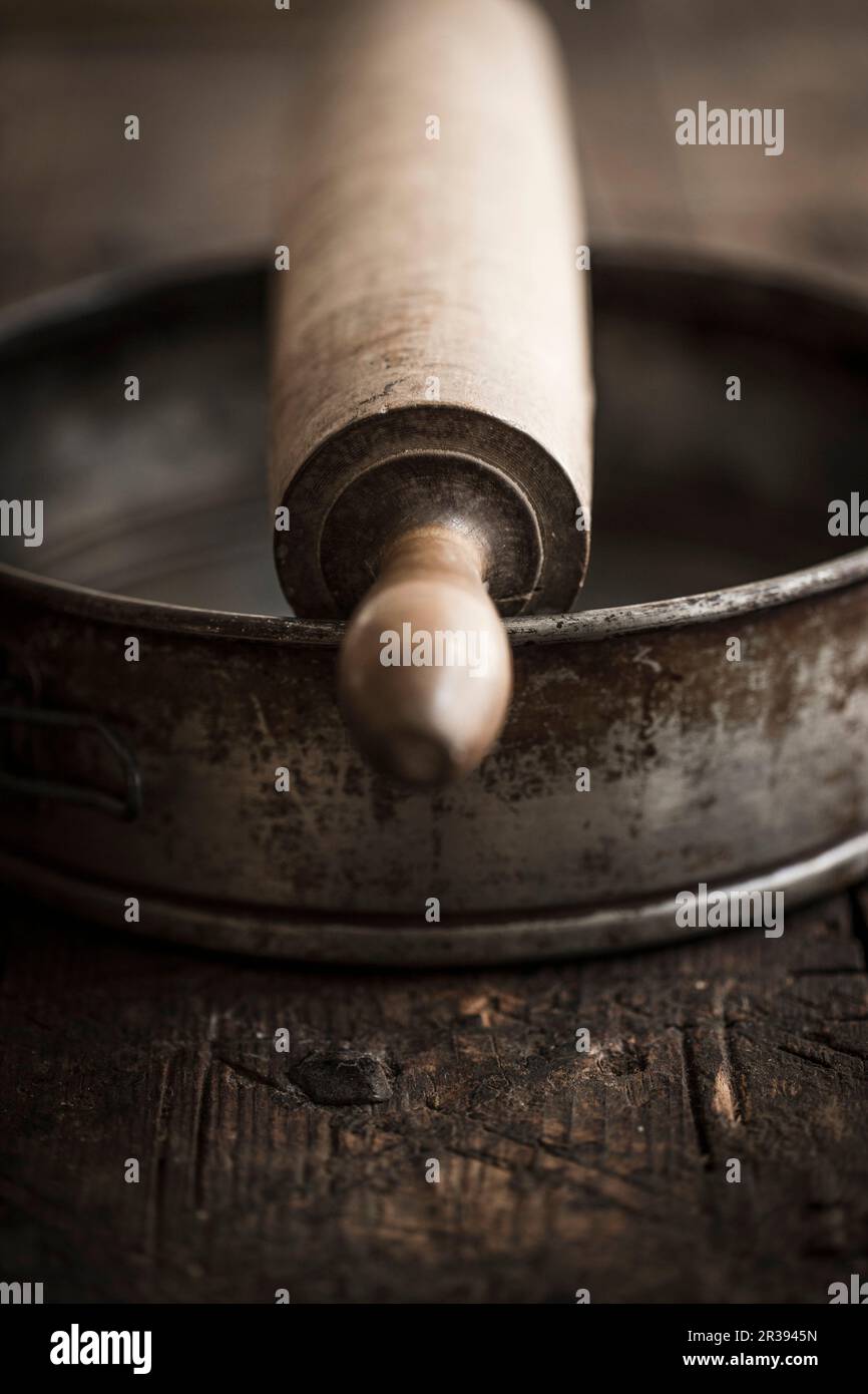 An antique cake tine and a rolling pin Stock Photo - Alamy
