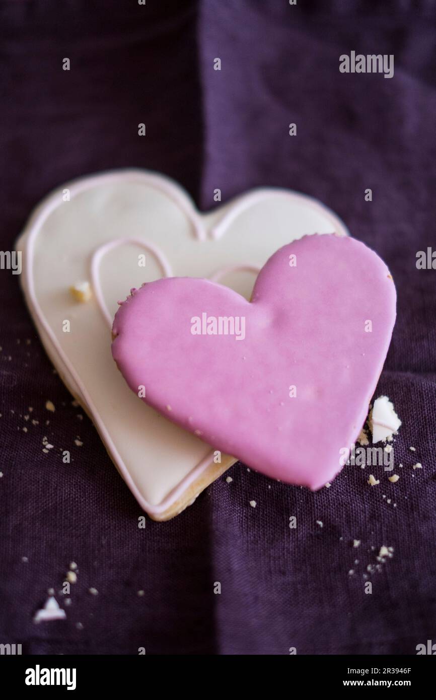 Two heart-shaped biscuits with icing Stock Photo - Alamy