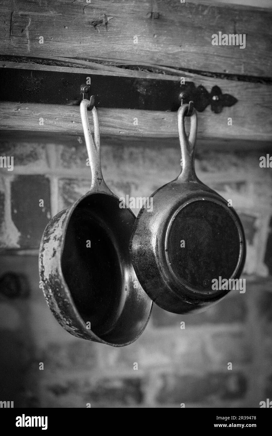 Frying pans hanging kitchen Black and White Stock Photos & Images - Alamy