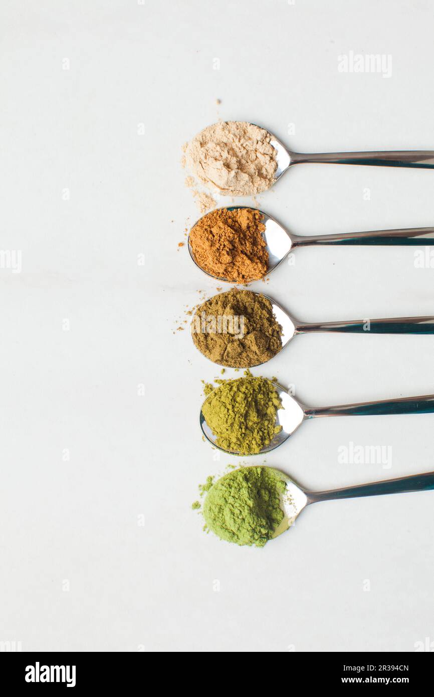 Spoons with different colorful superfood powders on table Stock Photo ...