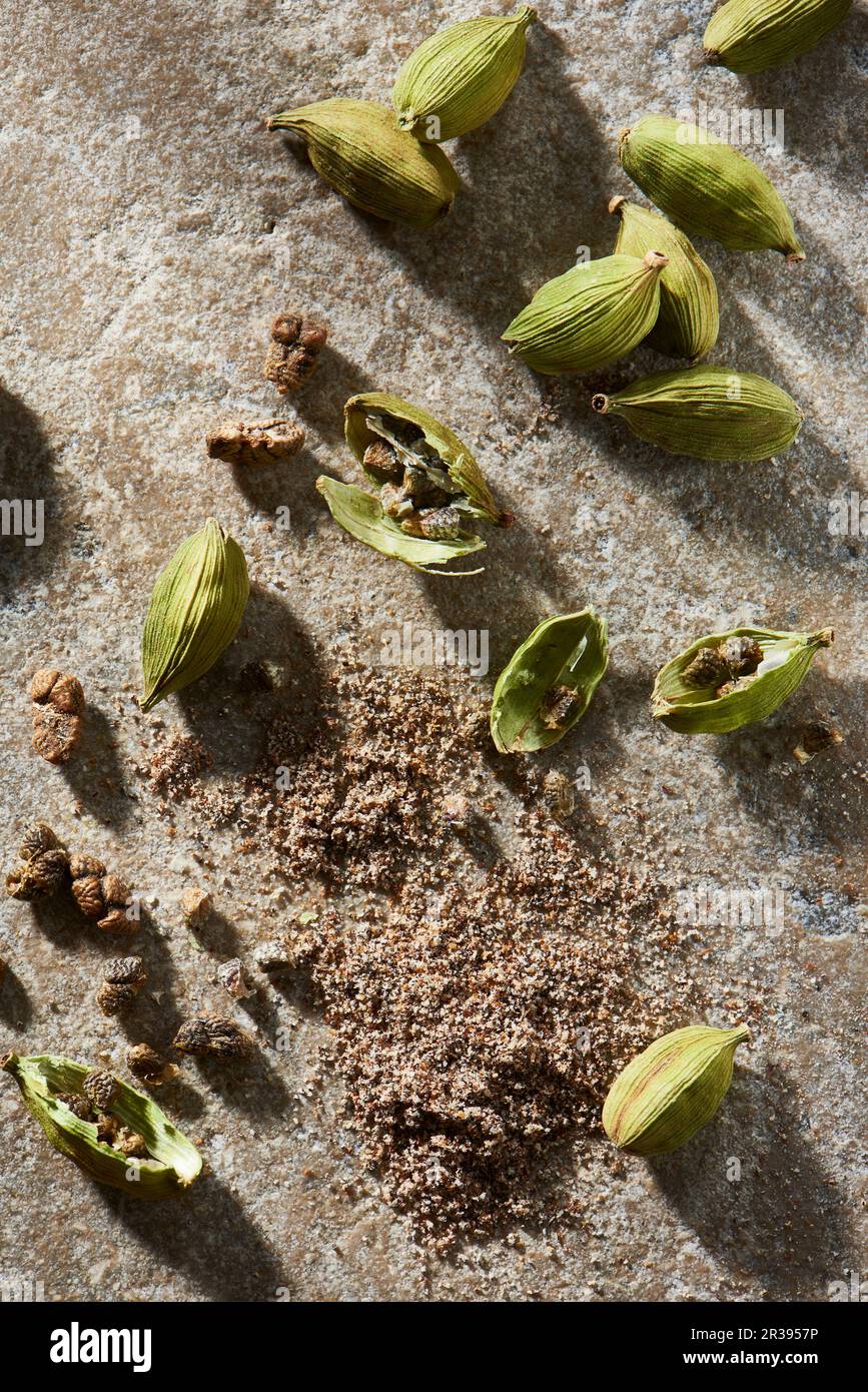 Cardamom pods with ground cardamom on stone from overhead Stock Photo ...