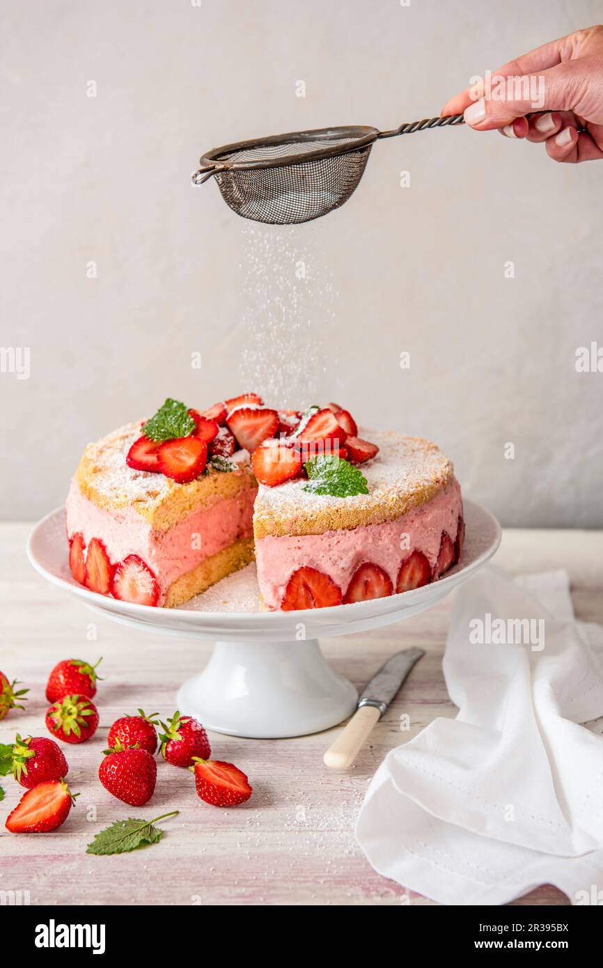 Strawberry mousse cake sliced removed Stock Photo - Alamy