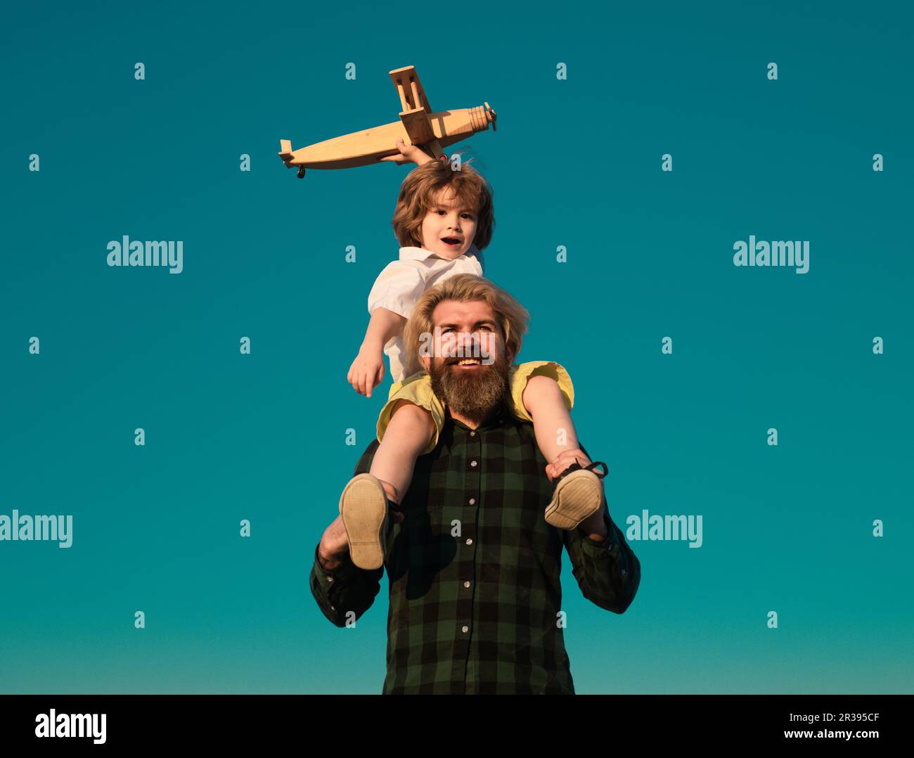Sweet childhood. Happy father and son with airplane dreams of traveling ...