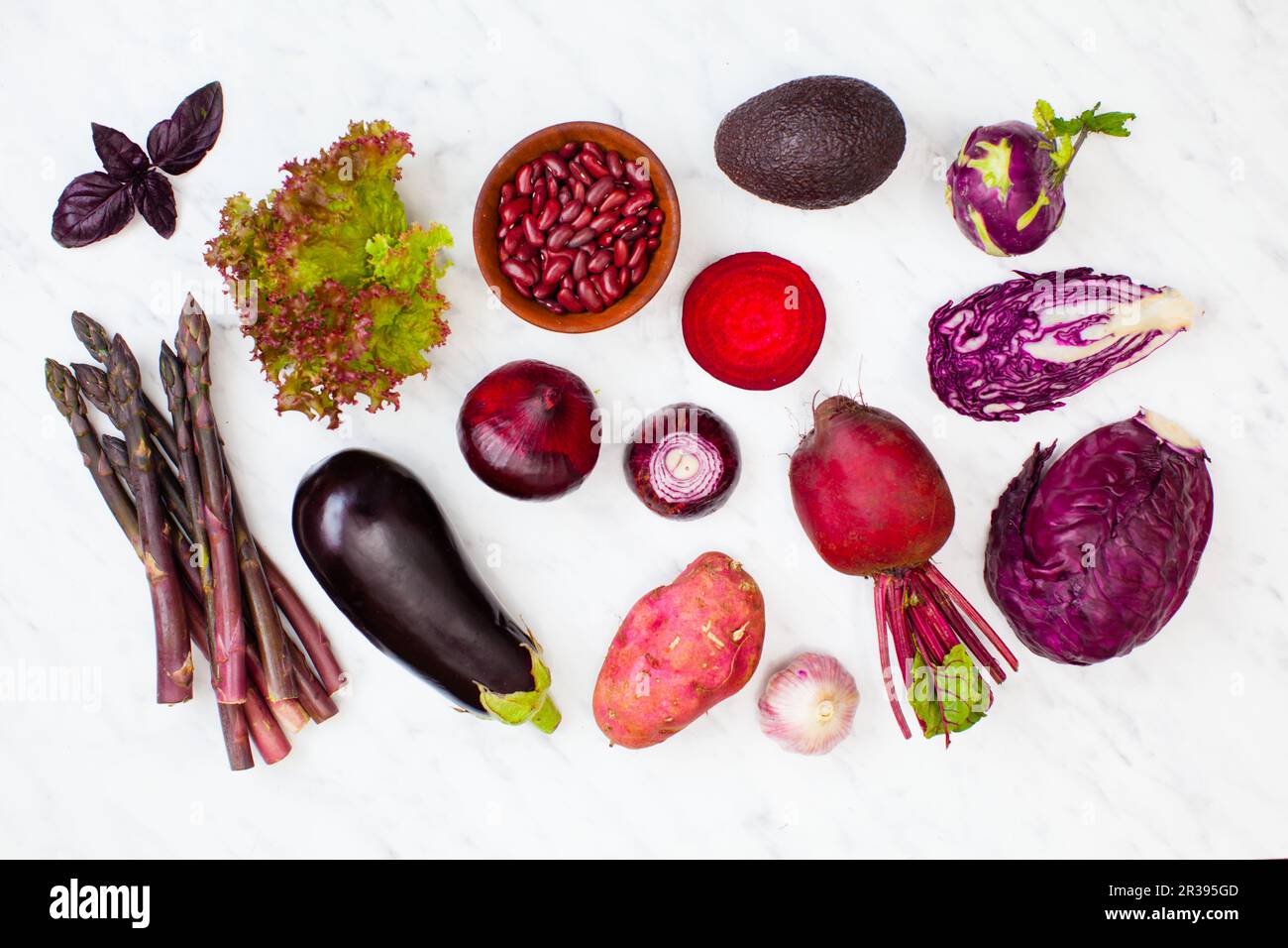 Fresh raw purple vegetables lay on the white marble Stock Photo - Alamy