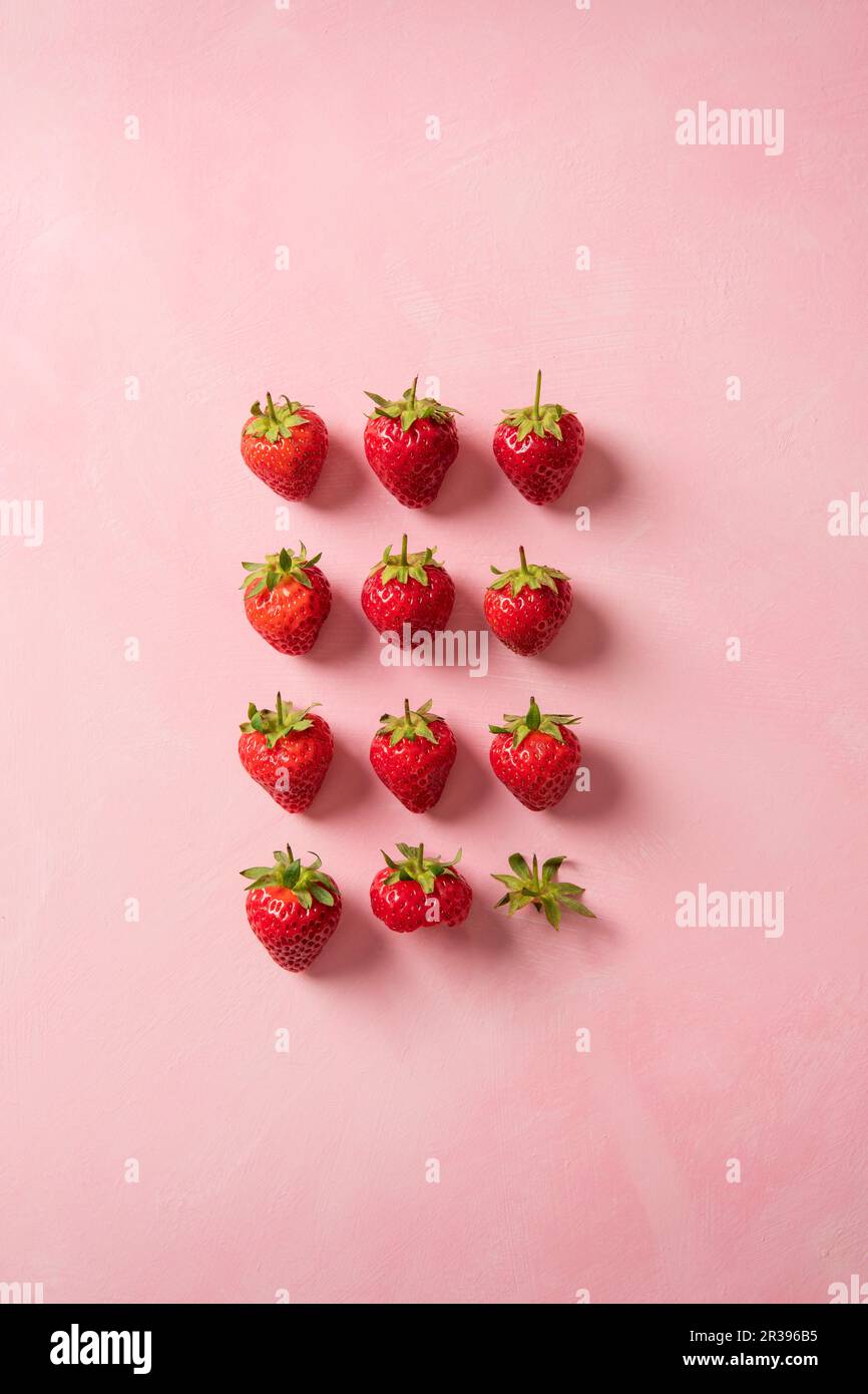 Four rows of strawberries, with two eaten Stock Photo - Alamy