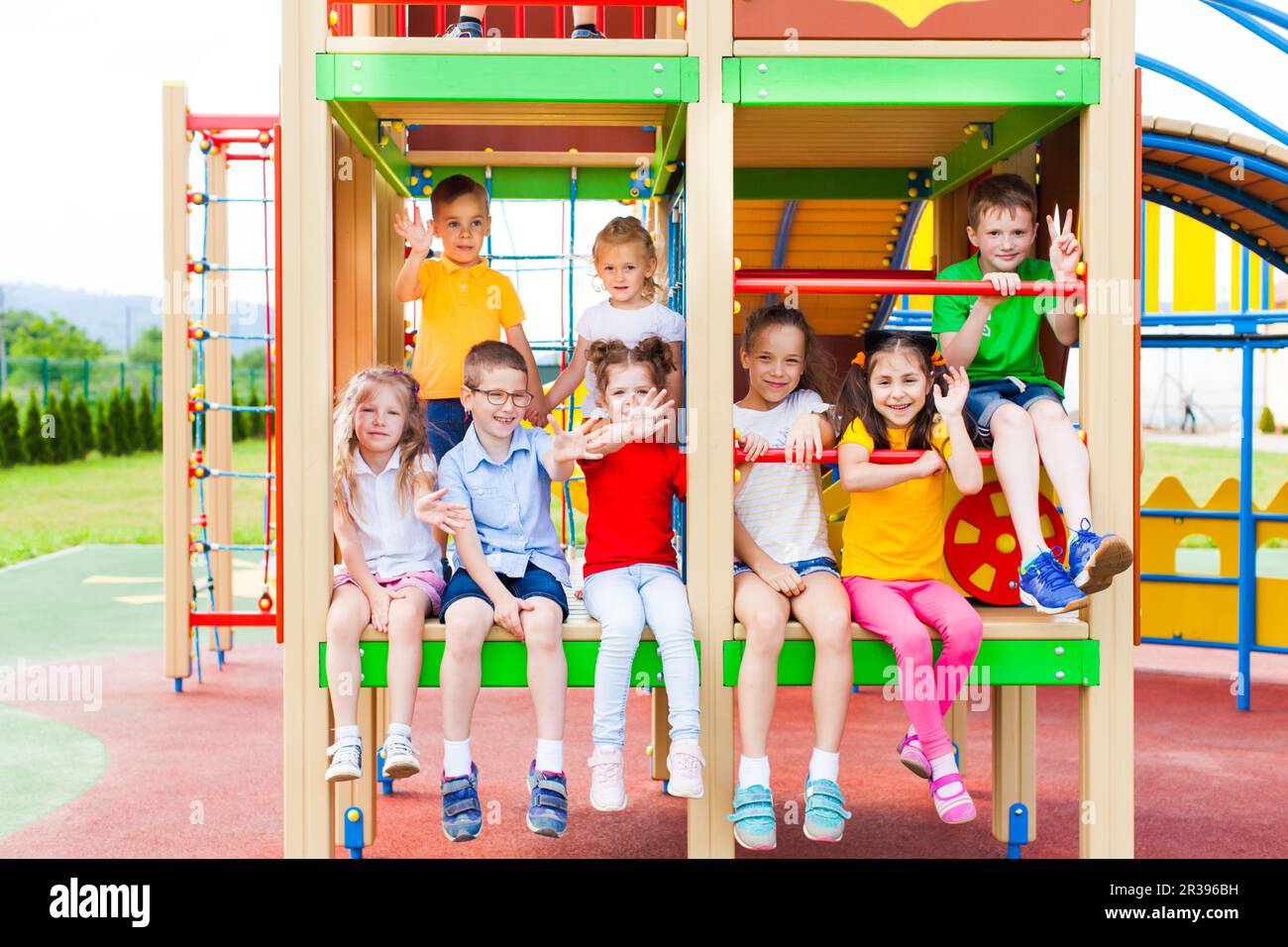 Kids sitting together on construction at playground Stock Photo - Alamy