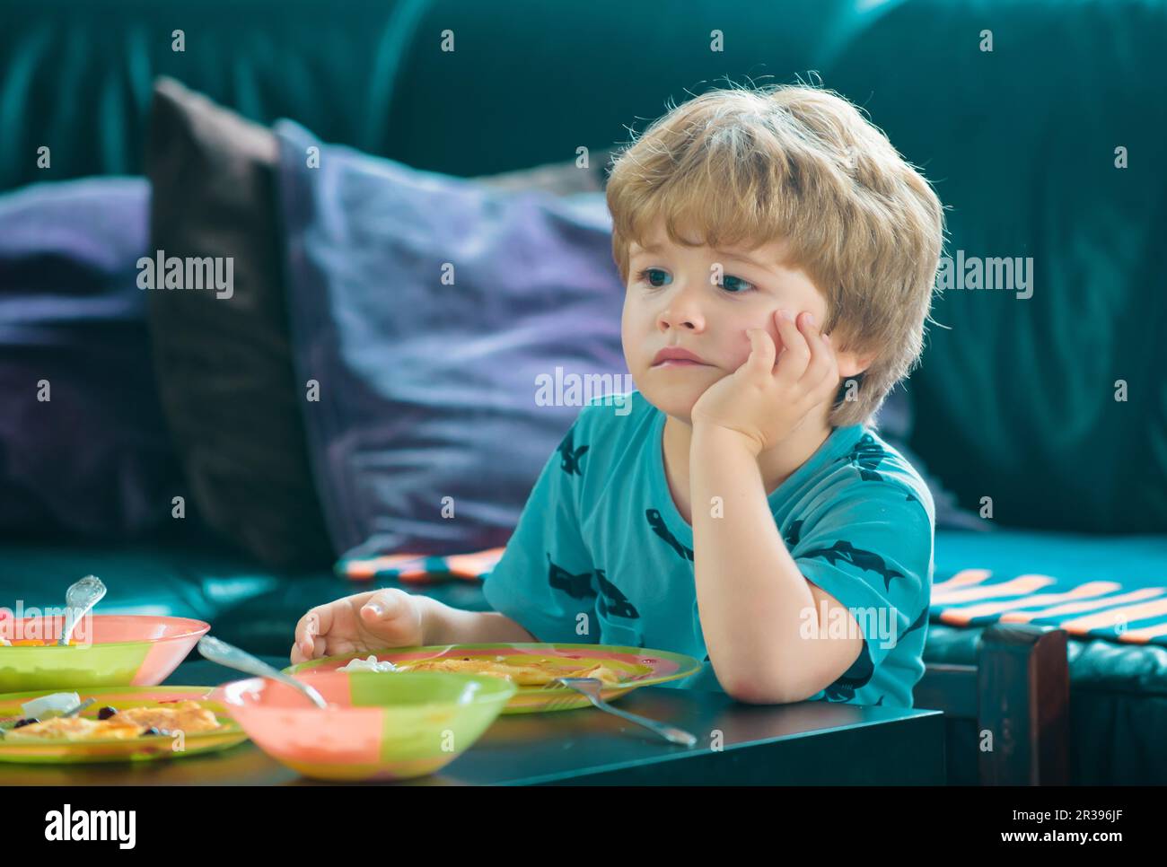 Baby child eating food. Kid boy eating healthy food Stock Photo - Alamy