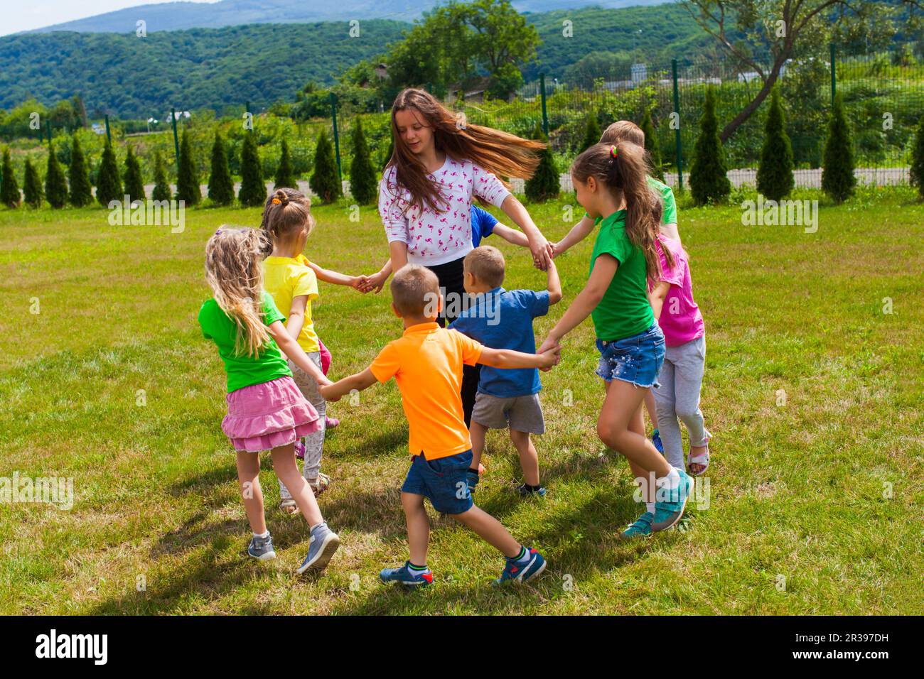 Children are dancing holding hands in the circle Stock Photo - Alamy