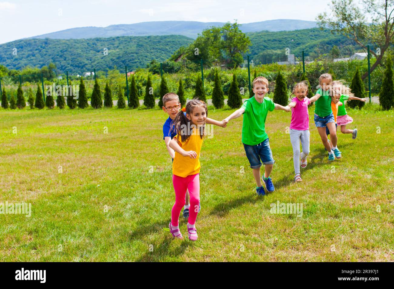 Kids follow the girl, happy time with friends Stock Photo - Alamy