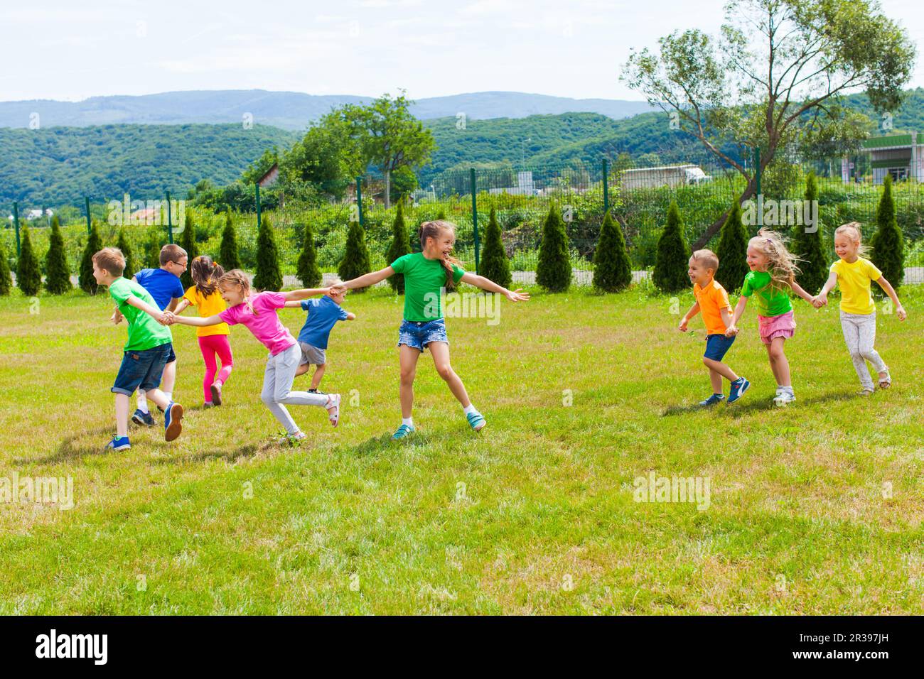 Kids have fun and run outdoors, following and laughing Stock Photo - Alamy