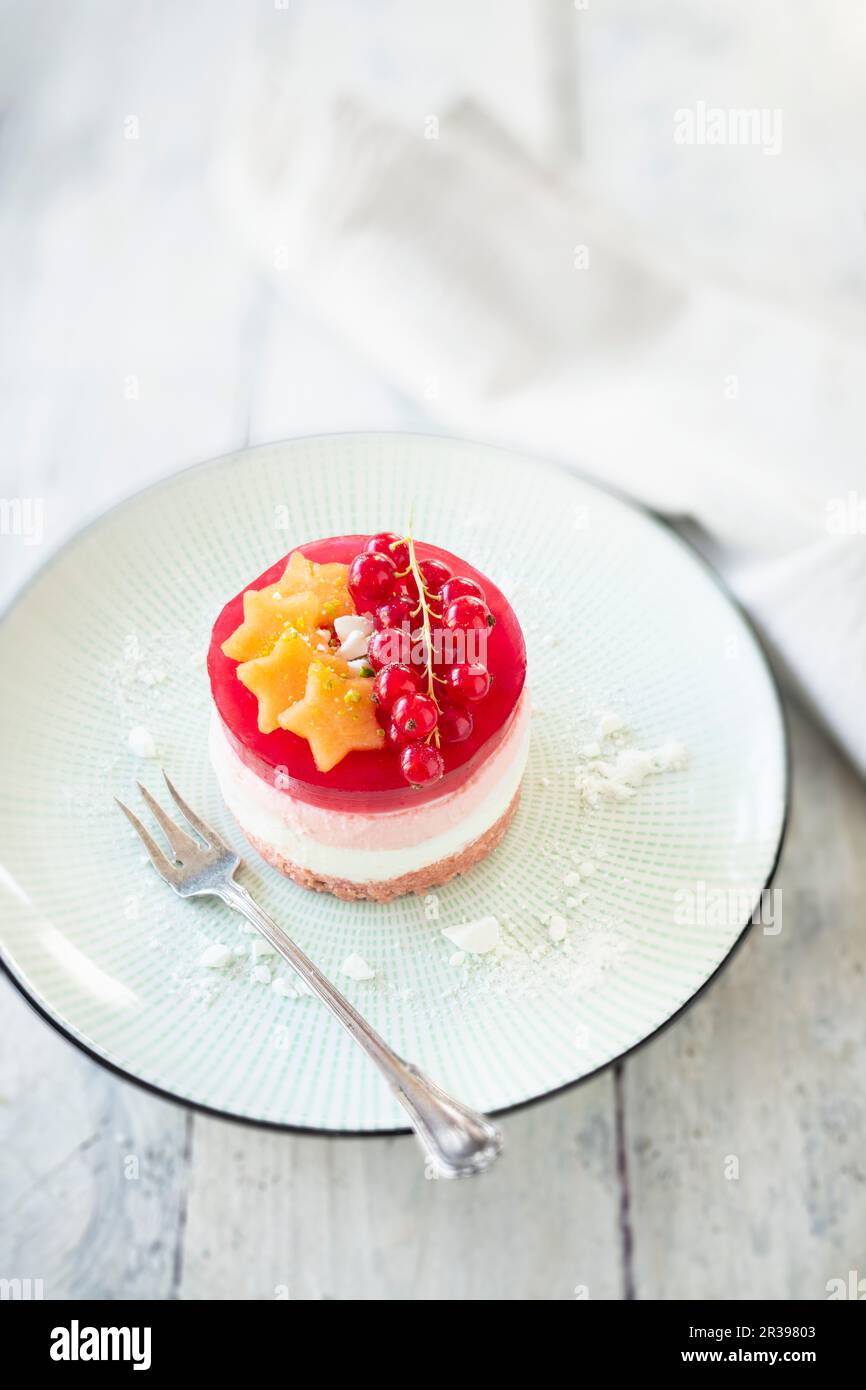 Cream cheese and redcurrant tartlet with a pink sponge finger base ...