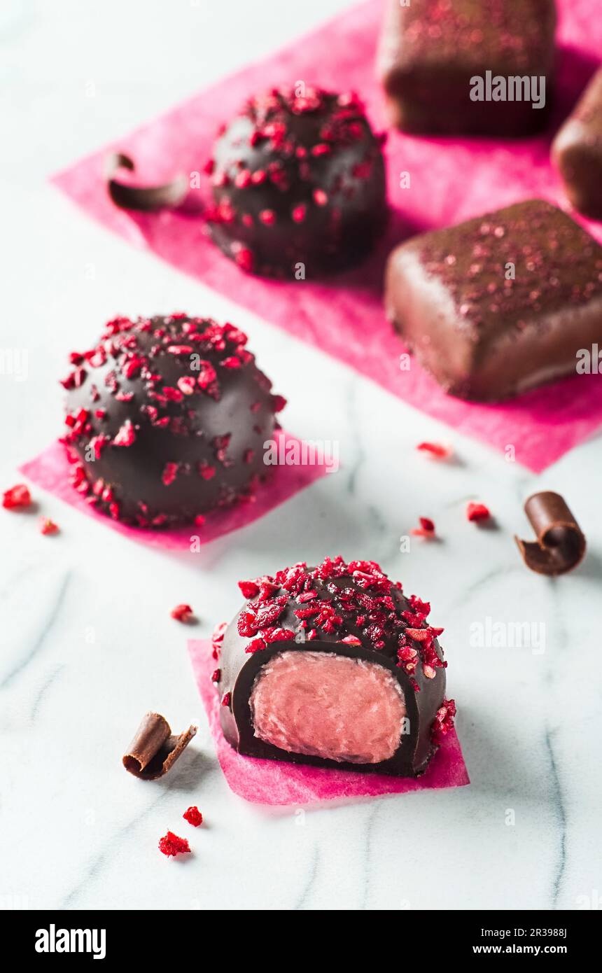 Raspberry and chocolate pralines Stock Photo - Alamy