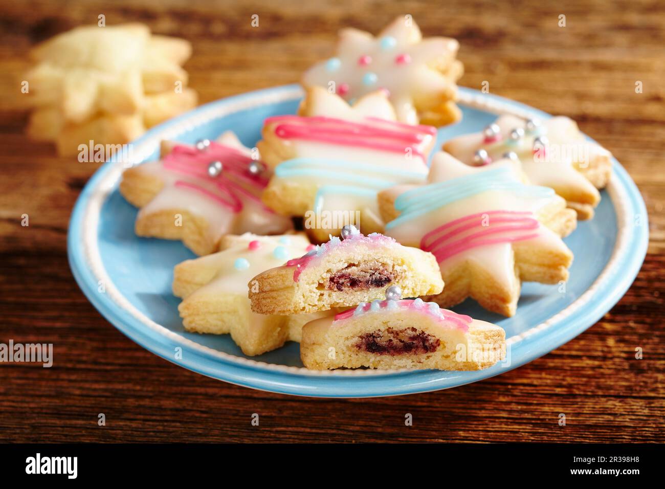 Colourful star biscuits with icing and filled with jam Stock Photo - Alamy