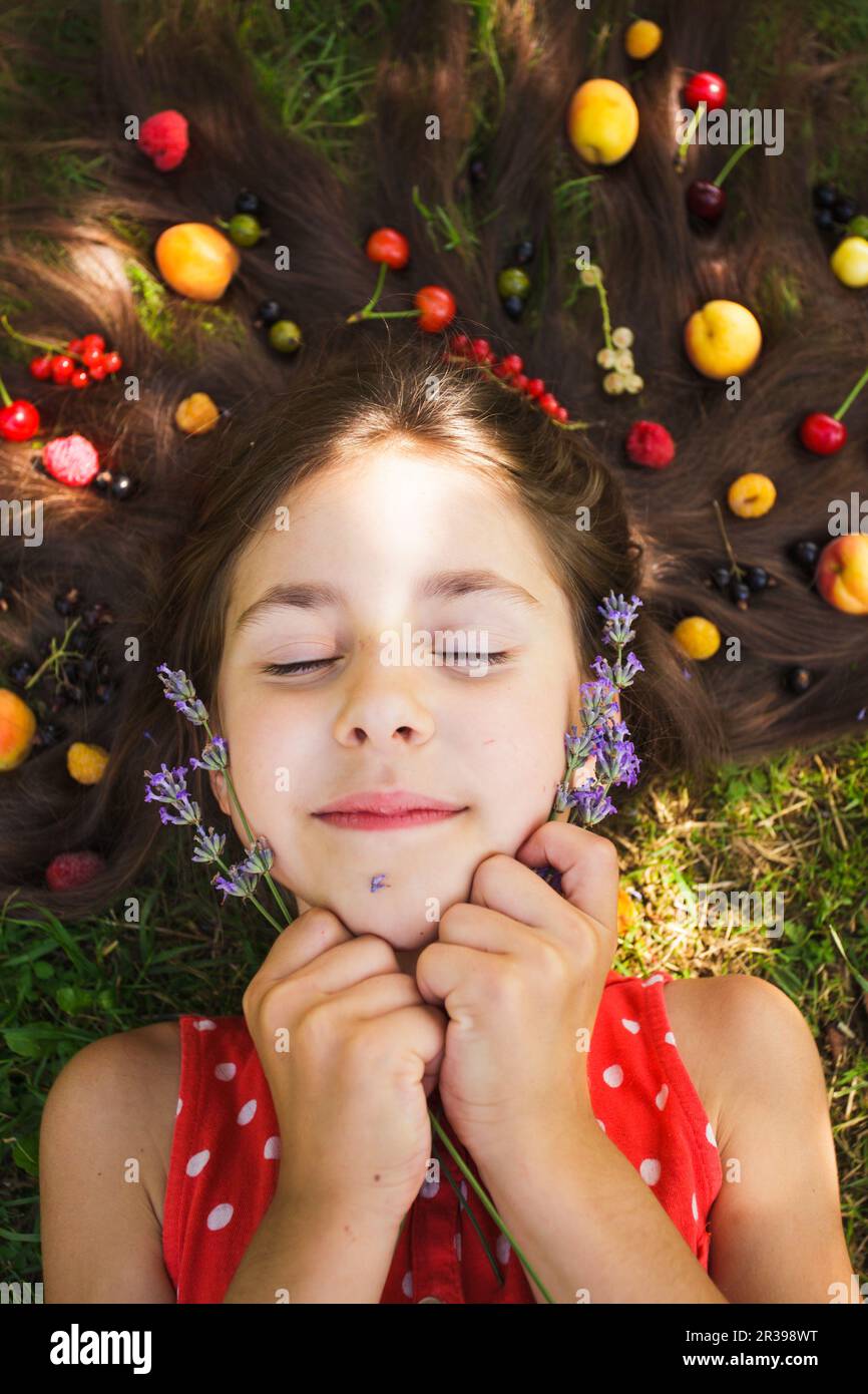 Taste and smell of summer, girl lay on the grass Stock Photo - Alamy
