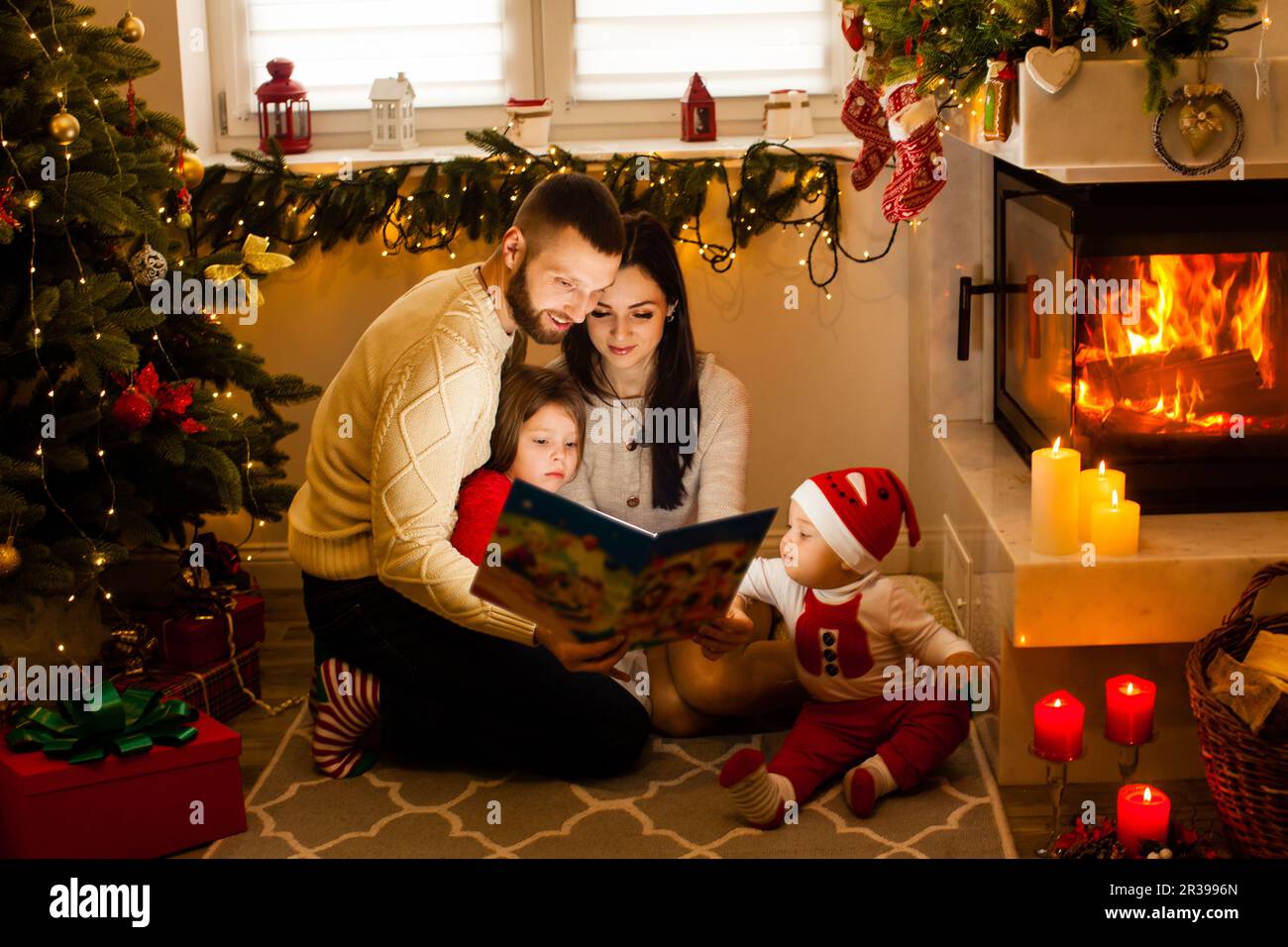 Happy family reading Christmas fairy tales. Christmas family traditions ...