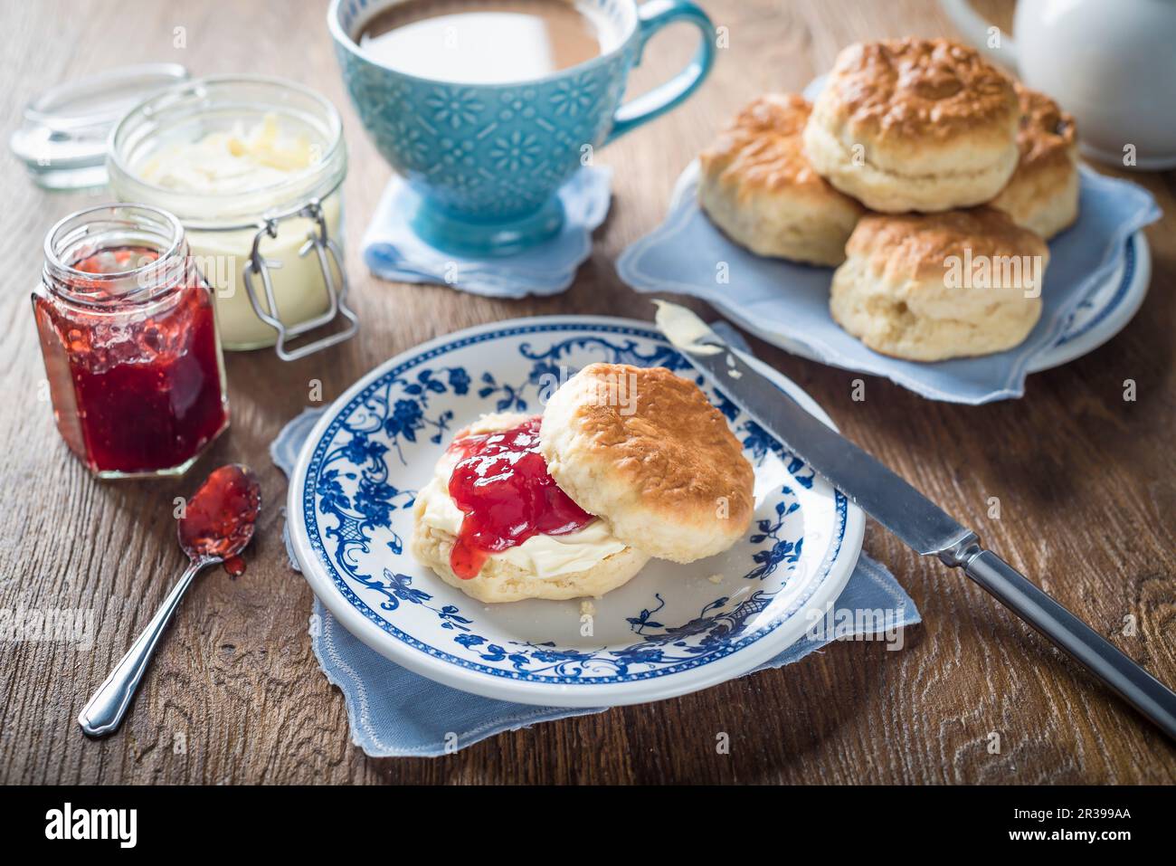 Scones with strawberry jam and clotted cream and tea Stock Photo - Alamy