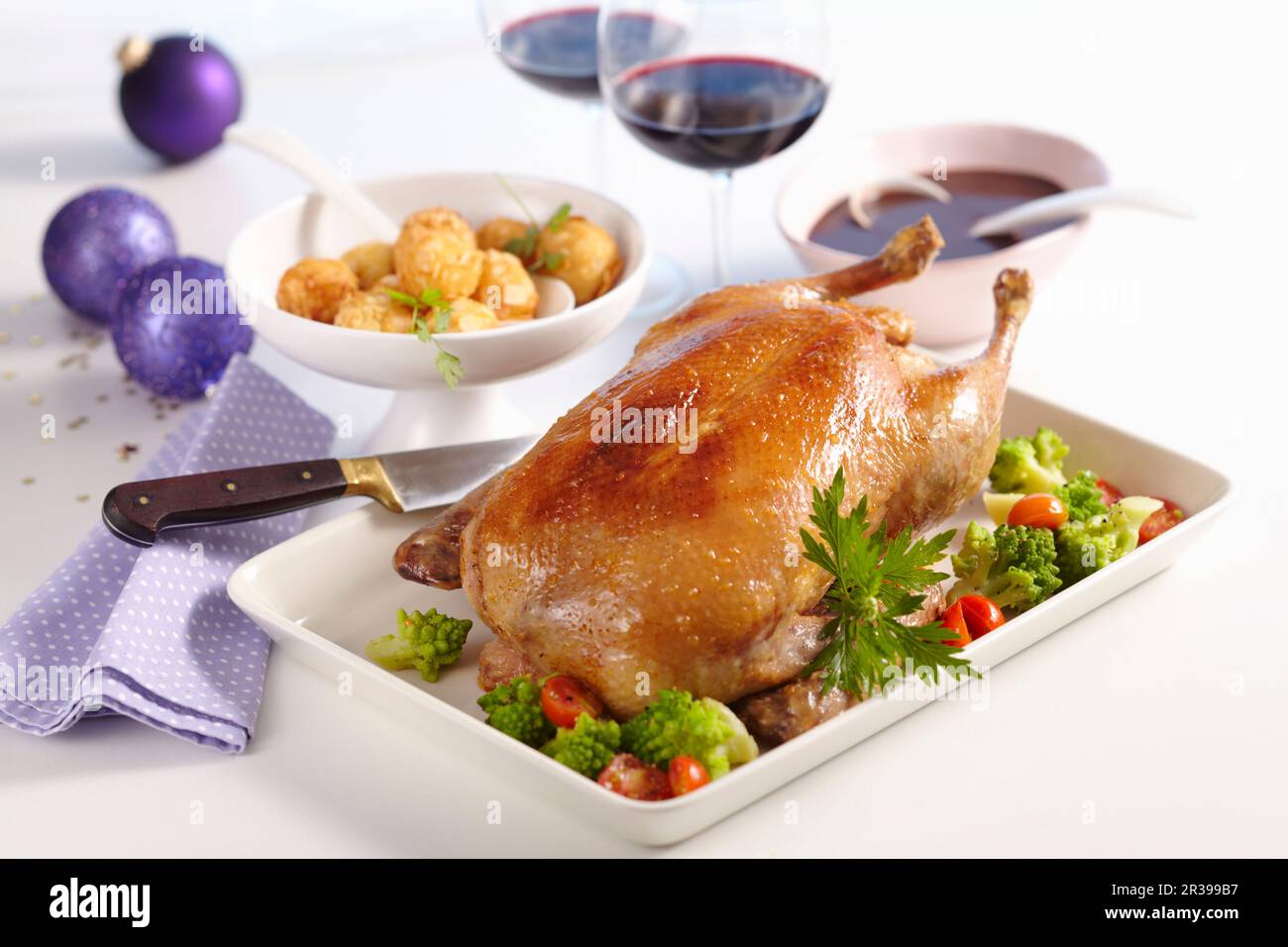 Roast duck with a minced meat stuffed, vegetables and potato and almond ...