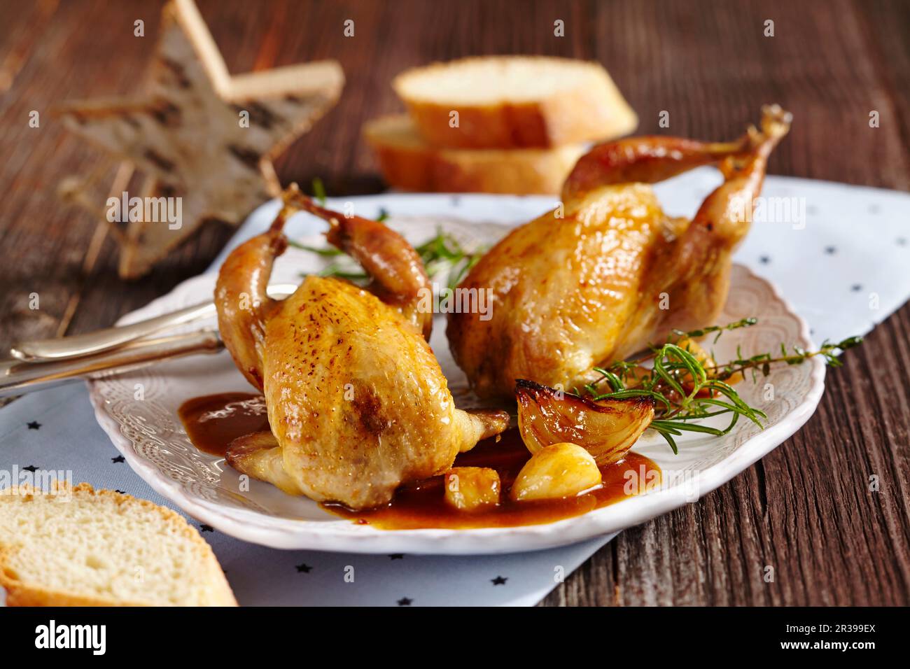 Spanish-style garlic quail with gravy and white bread Stock Photo - Alamy