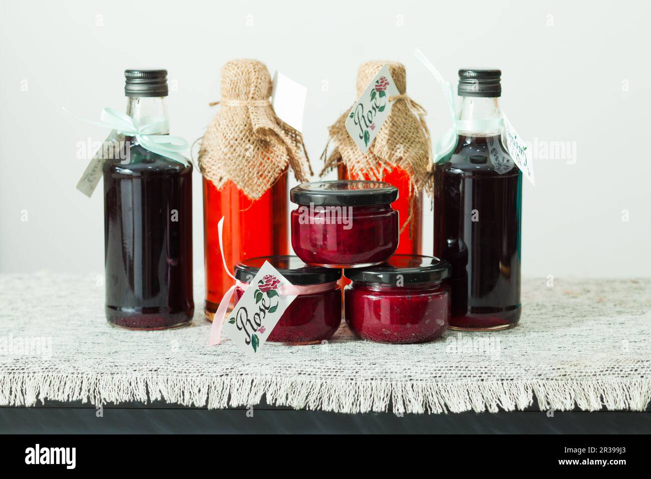 Homemade rose petal jam and berries syrup in bottles Stock Photo - Alamy