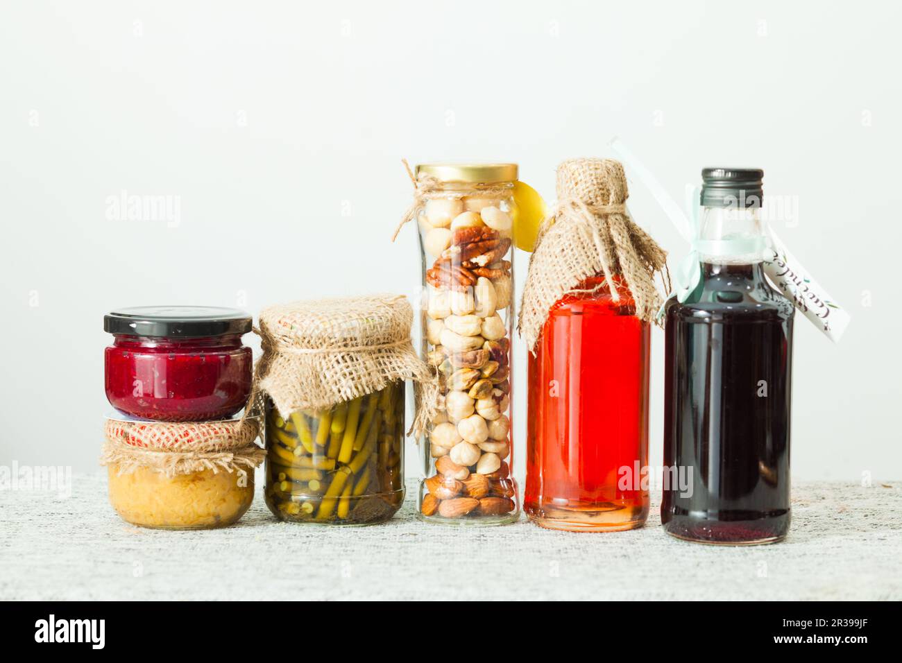 Homemade sauce, seasoning and berry syrup on white table Stock Photo ...