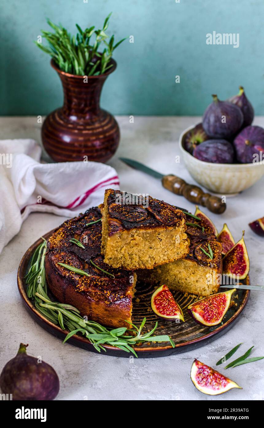 Inverted pie in a cut with figs, rosemary and honey on a concrete ...