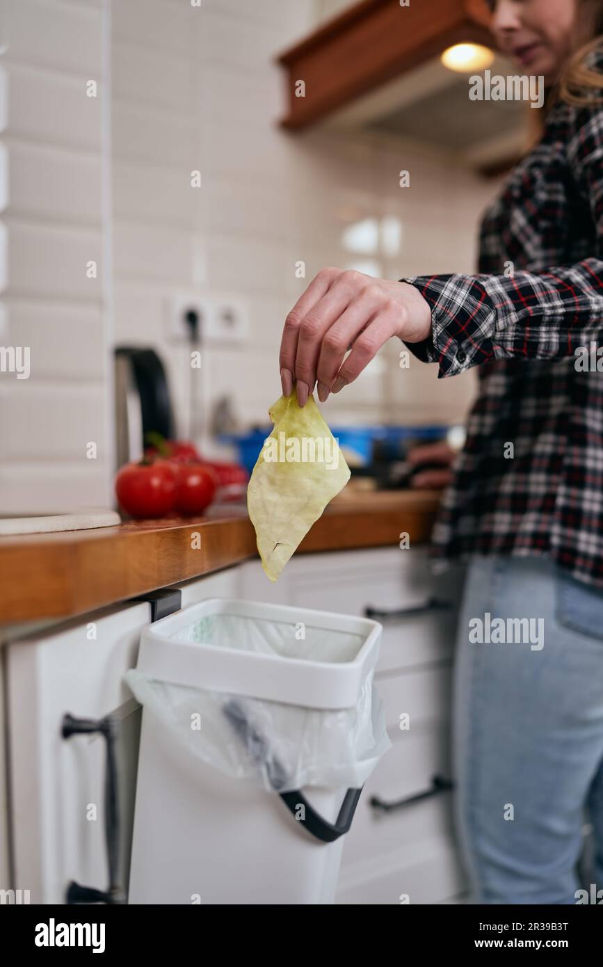 The cook throwing food peels in a compost bin for fermentation ...