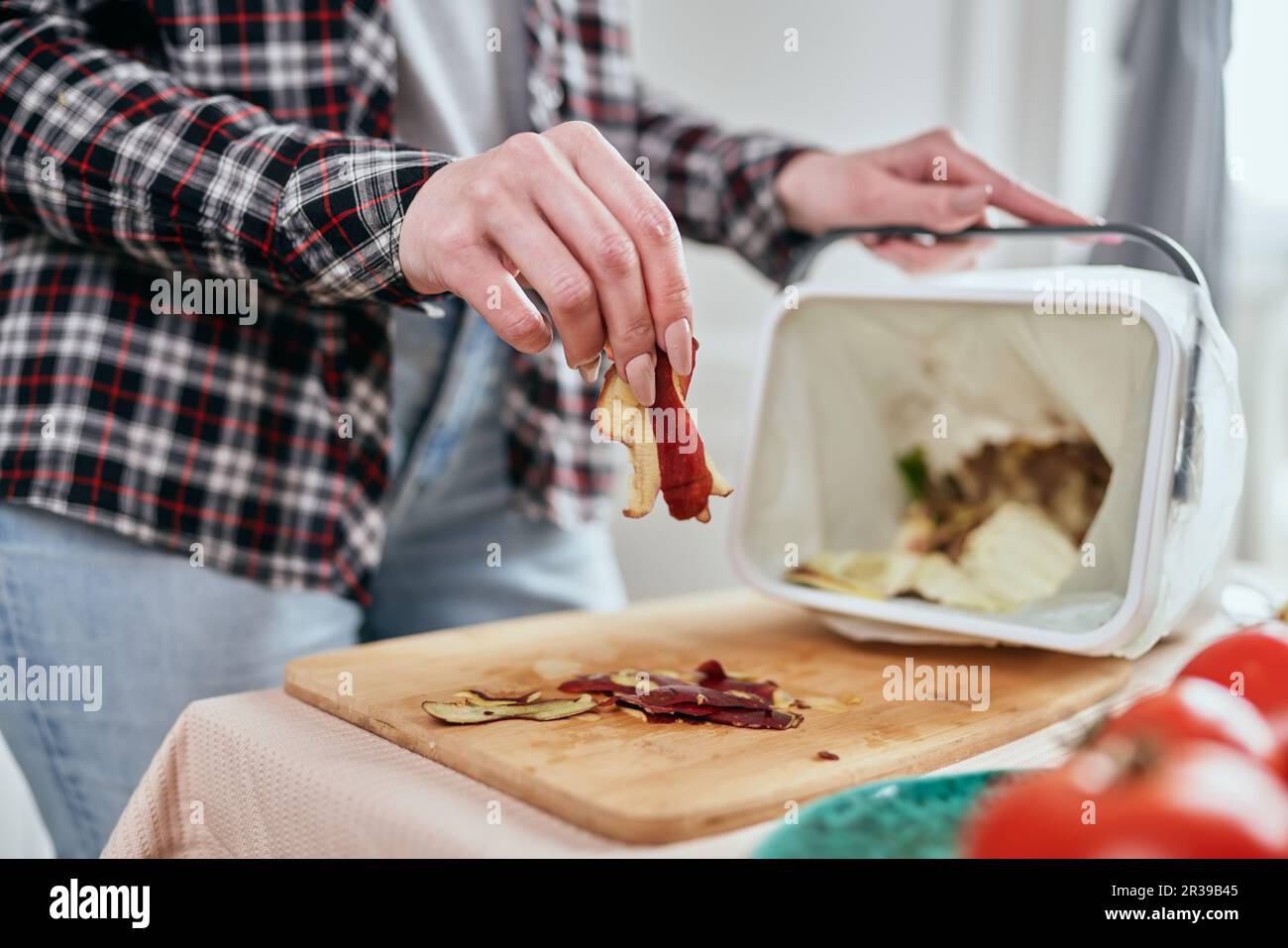 Female person throwing food leftovers in a bokashi bin for biological ...