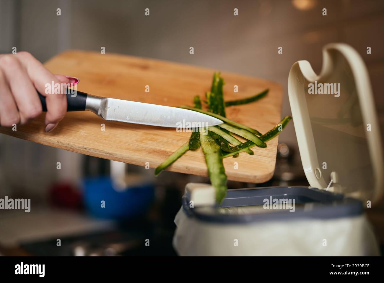 The cook recycling food peels in a compost bin. Female person throwing ...