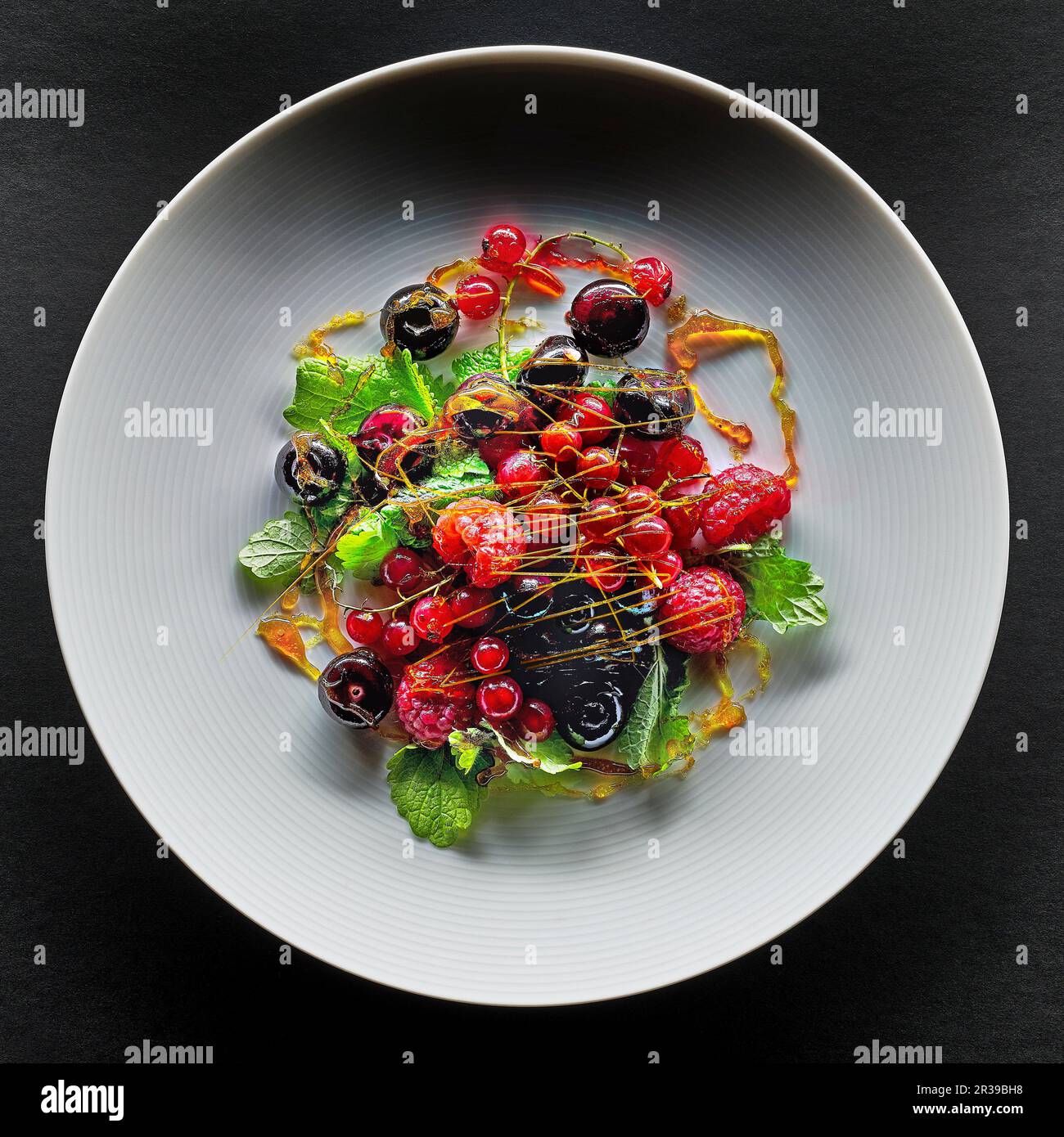Fruits of the forest with mint and caramel Stock Photo - Alamy