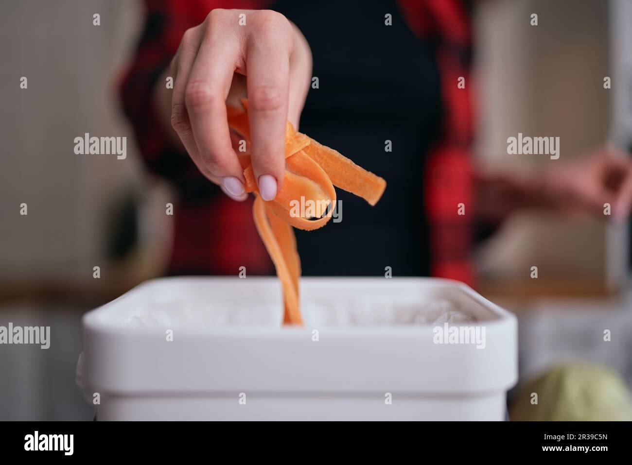 Female person throwing organic food leftovers in a bokashi bin for ...
