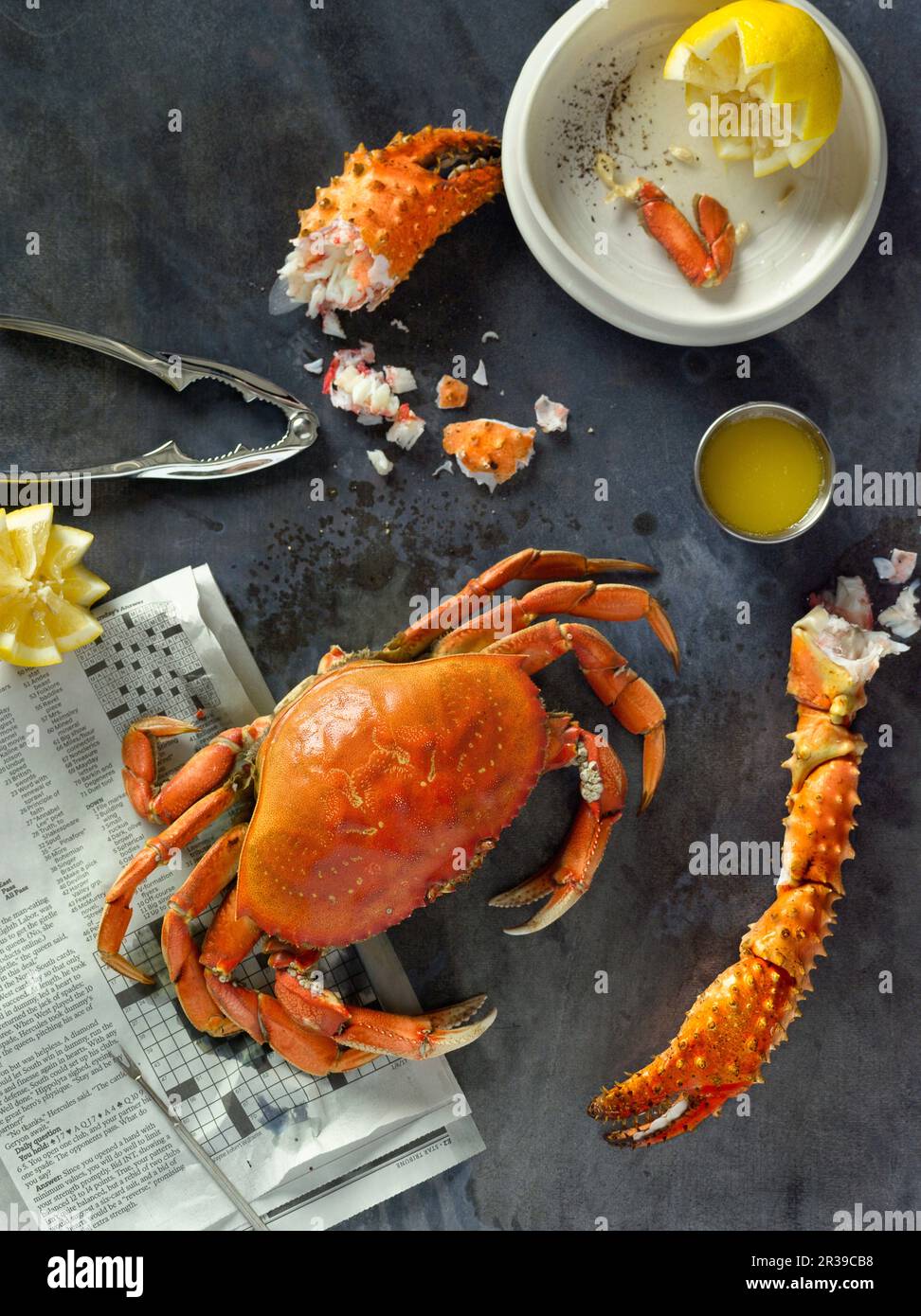 Cooked crab with a pair of crab crackers, melted butter and lemon (seen ...