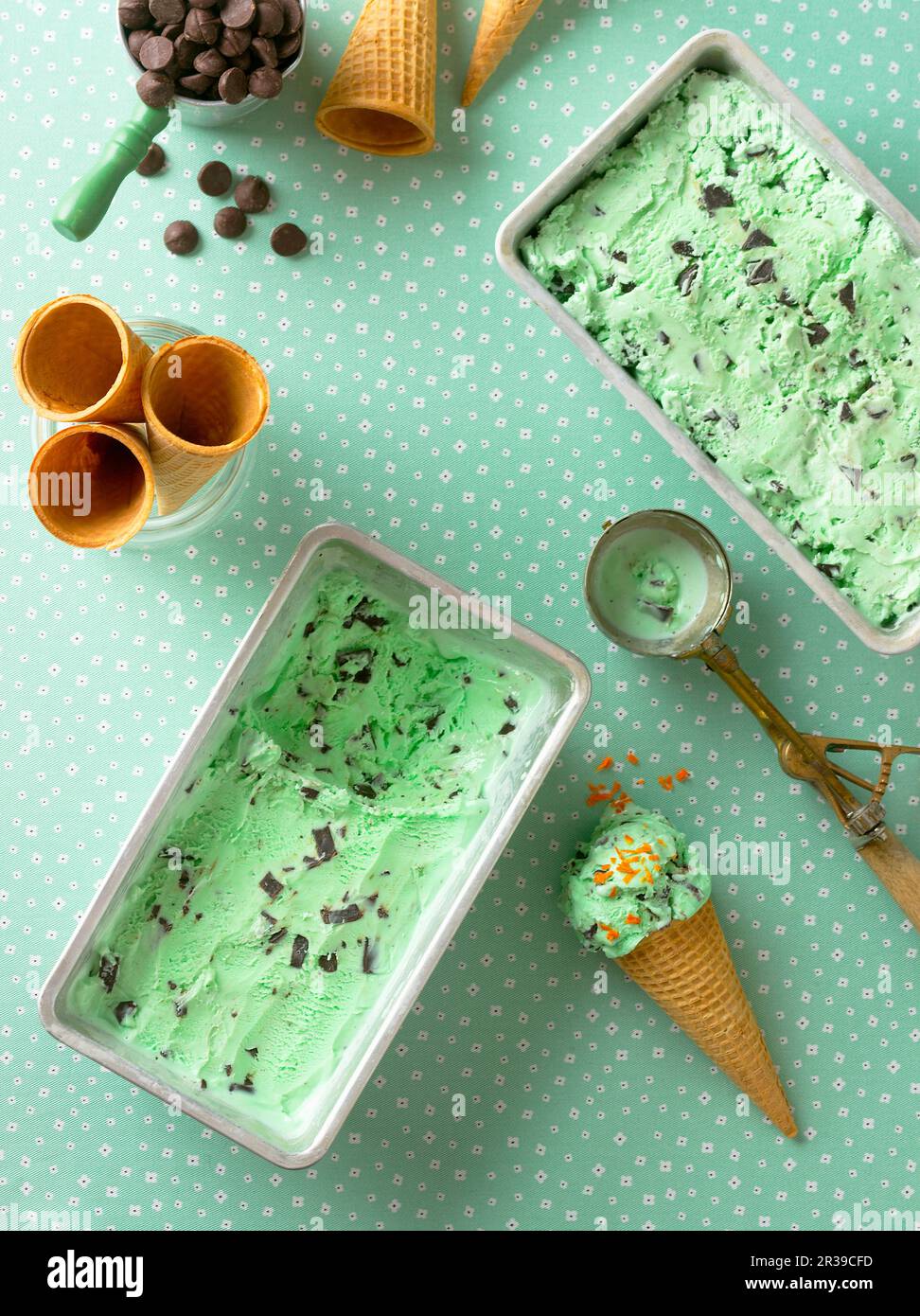 Homemade mint ice cream in metal containers and in cones Stock Photo ...