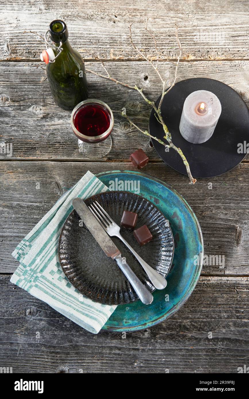 A vintage place setting with two chocolate covered marzipan and ...