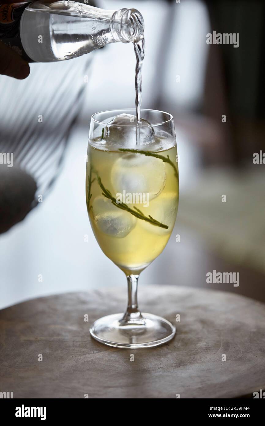A samphire and tonic cocktail being poured Stock Photo - Alamy