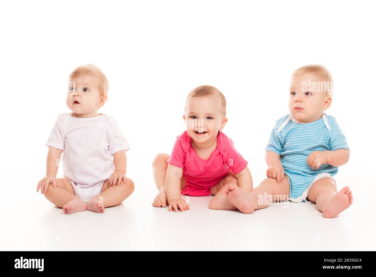 Cute babies sitting on white studio background Stock Photo - Alamy