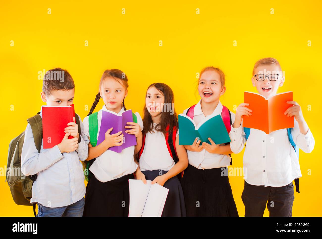 Happy excited smiling little students holding color books isolated on ...