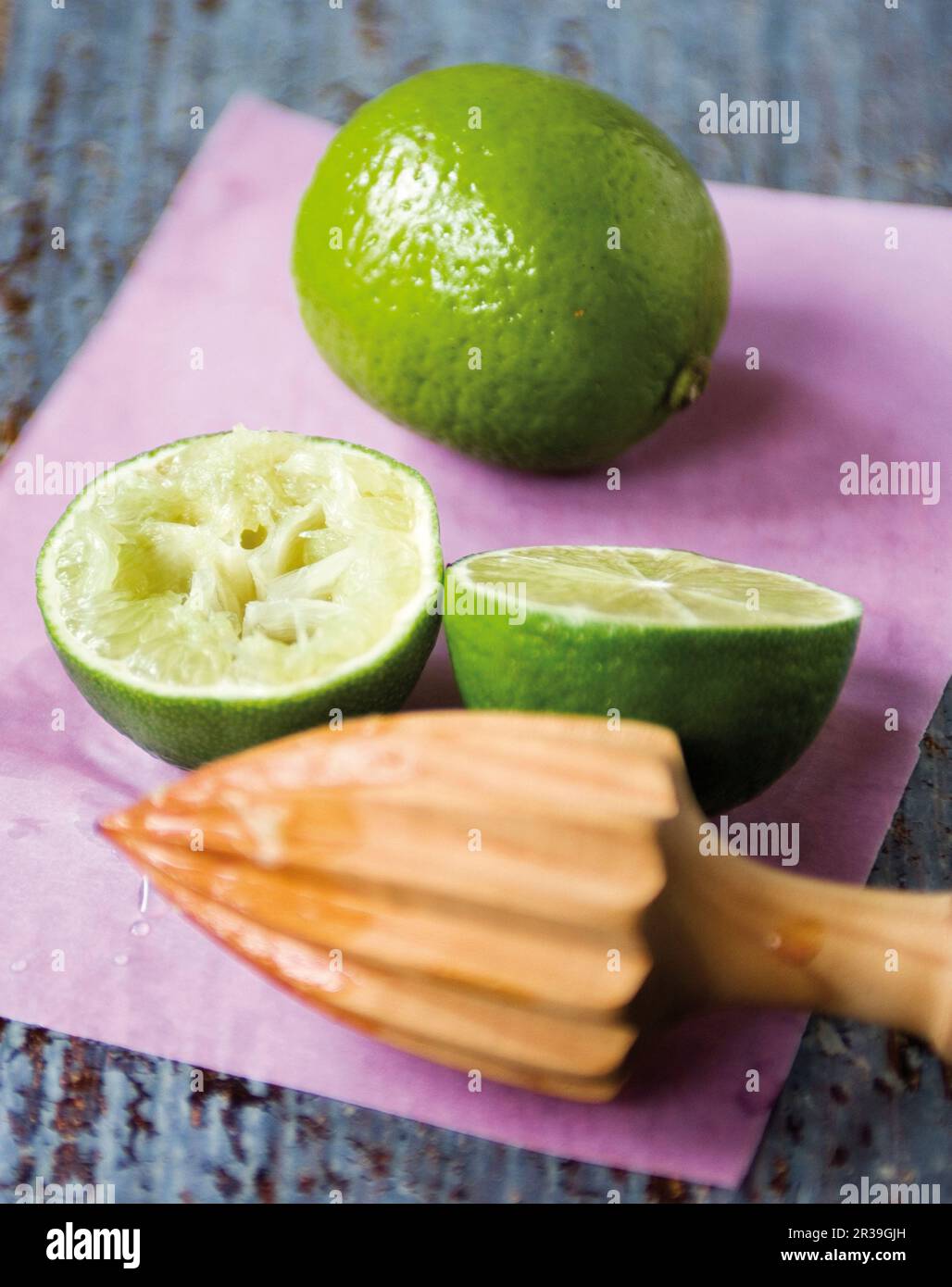Cut lime and whole one with wodden rimmer Stock Photo - Alamy