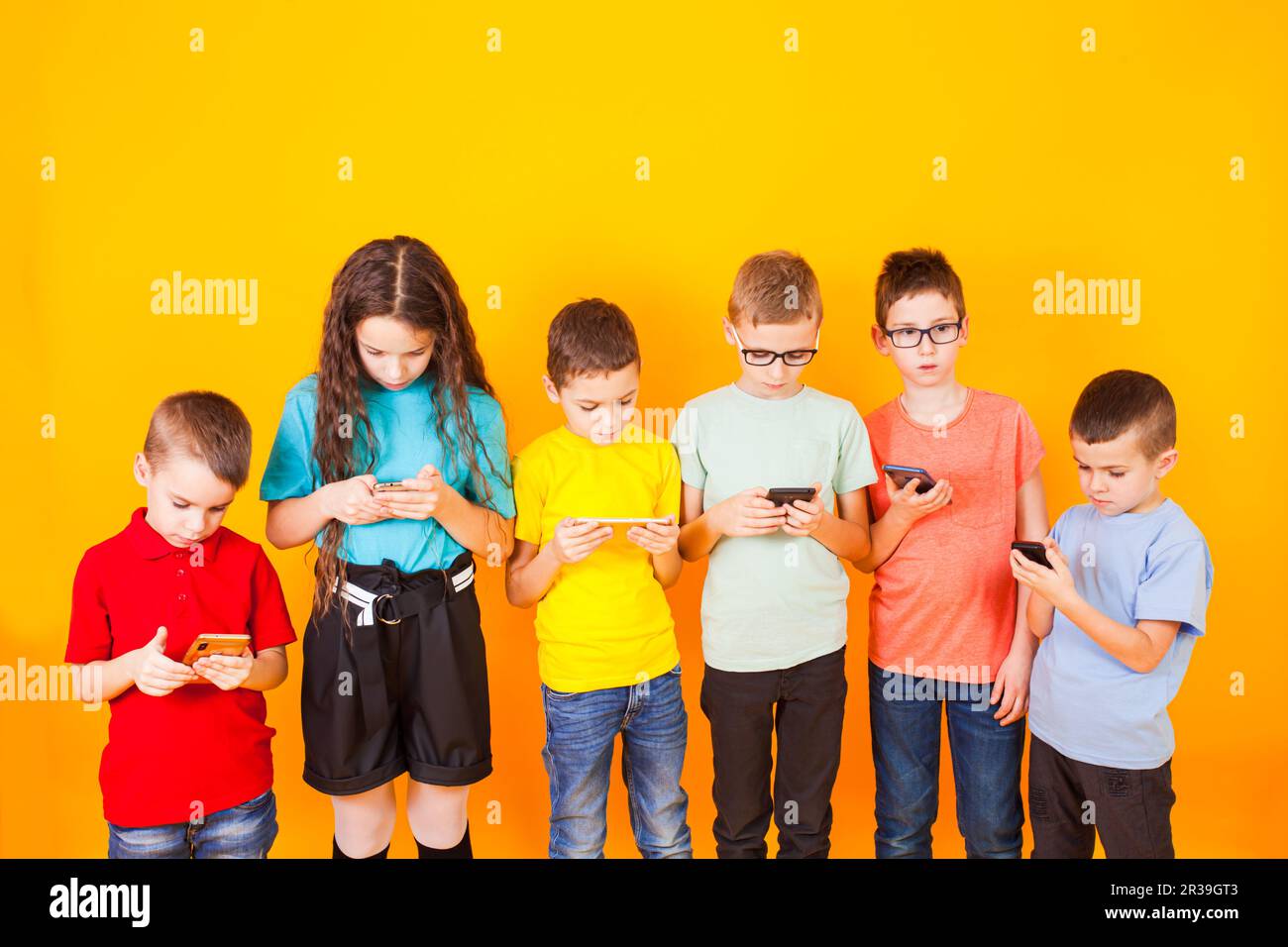 Young kids playing game on mobile phone Stock Photo - Alamy