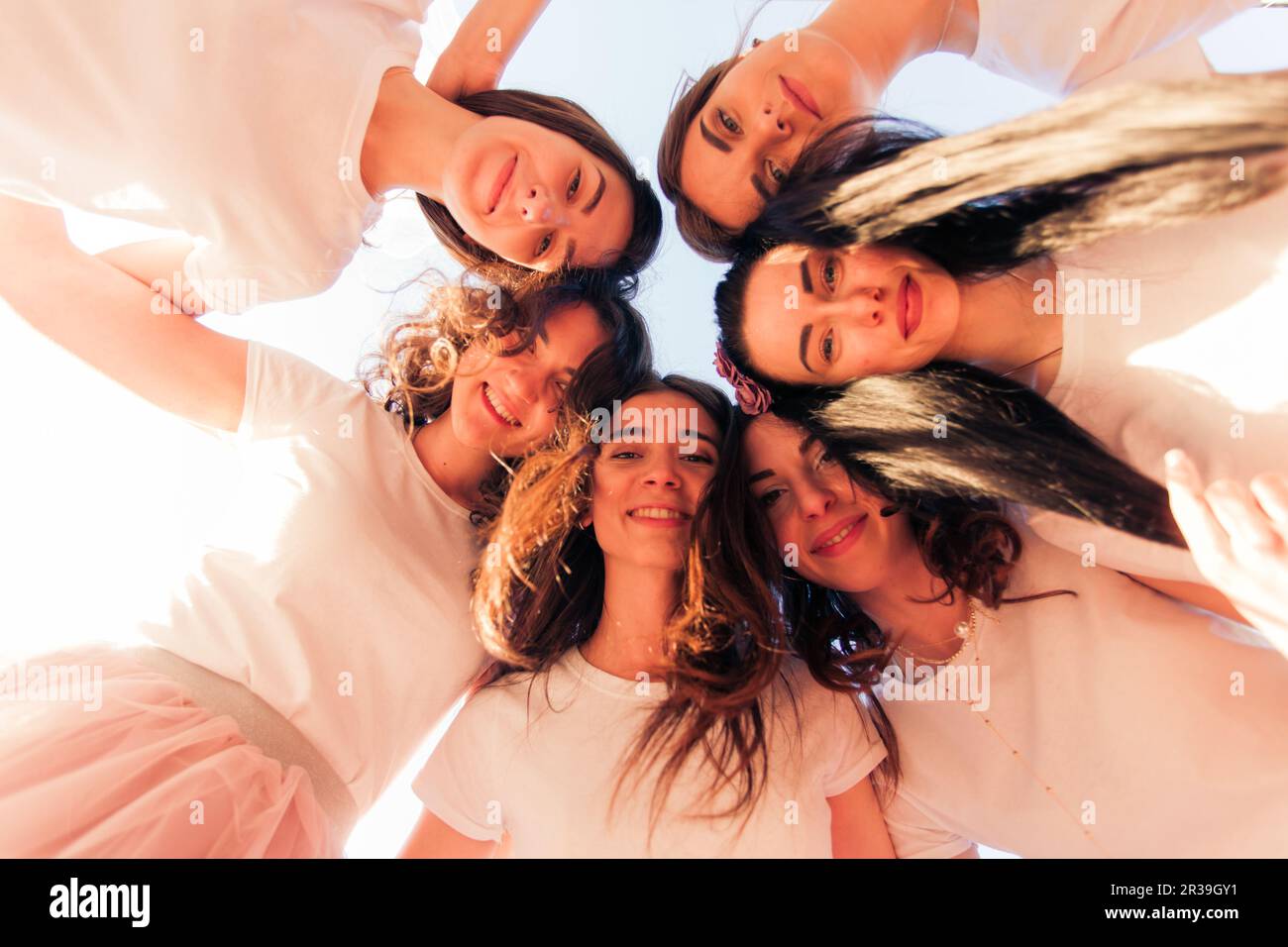 Group of girls looking down and smiling Stock Photo - Alamy