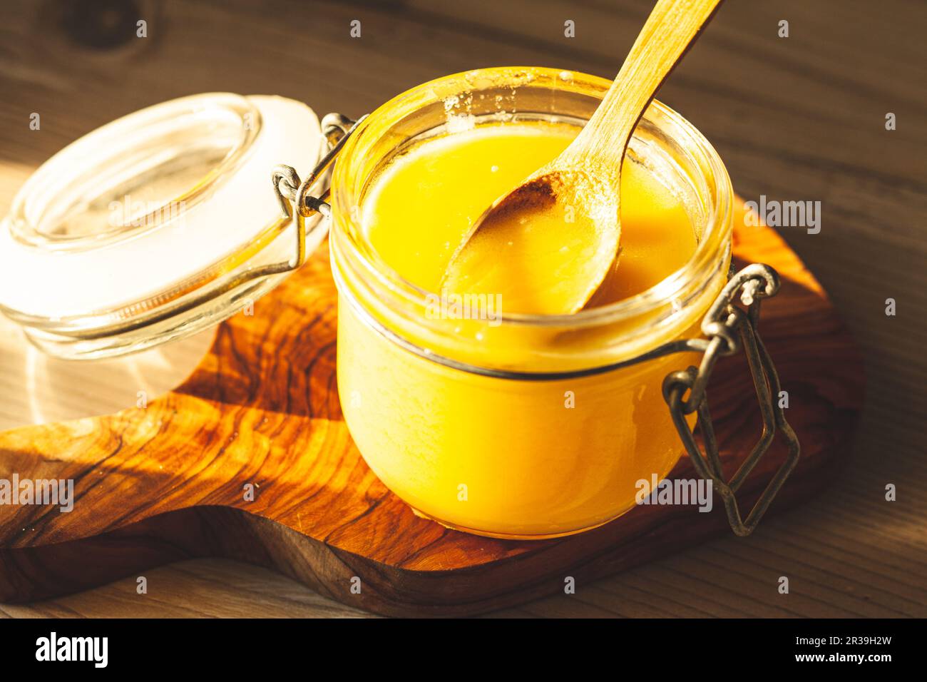 Wooden spoon with ghee - clarified butter on the kitchen Stock Photo ...