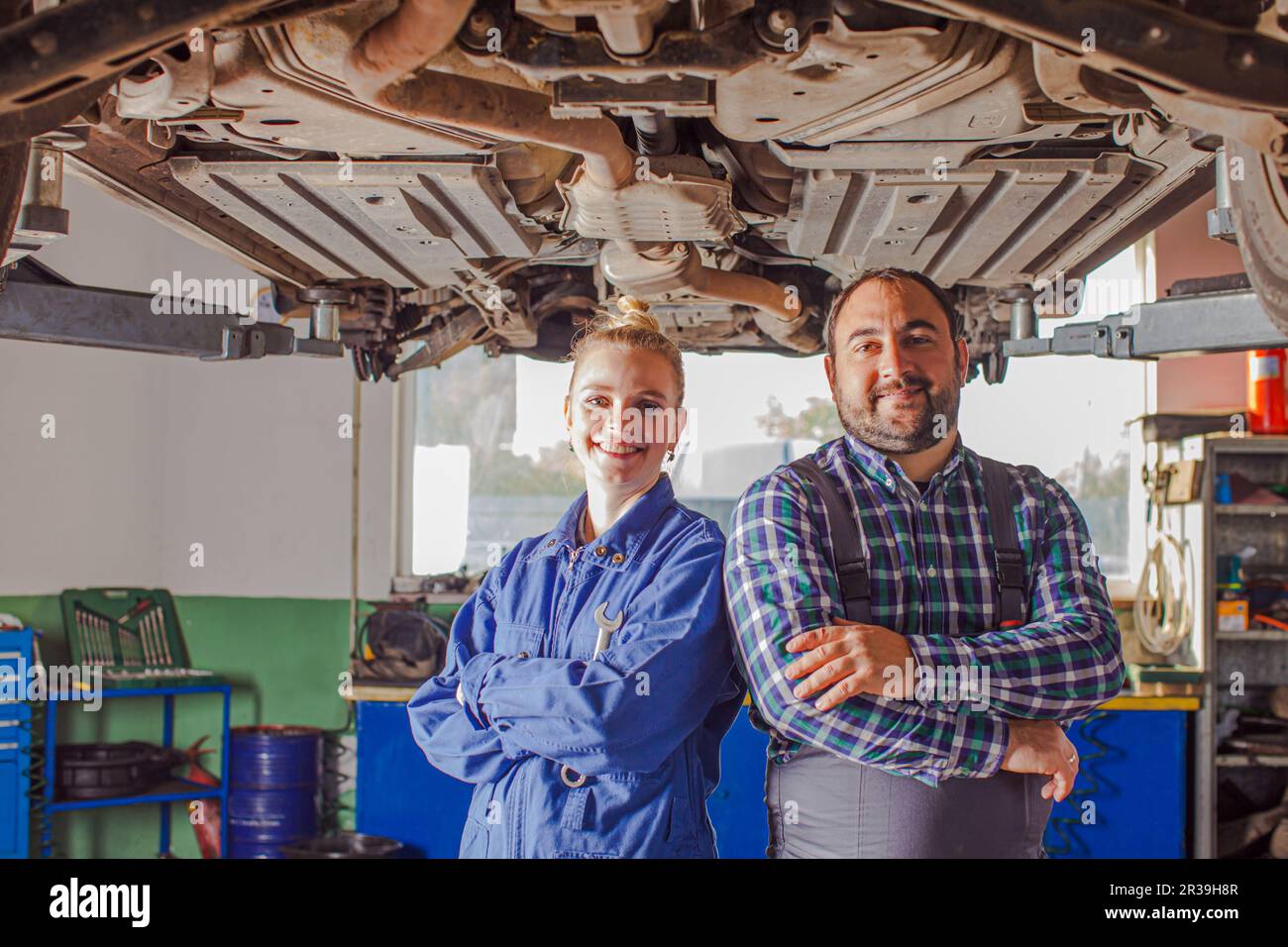 Successful team of mechanics standing with arms crossed Stock Photo - Alamy