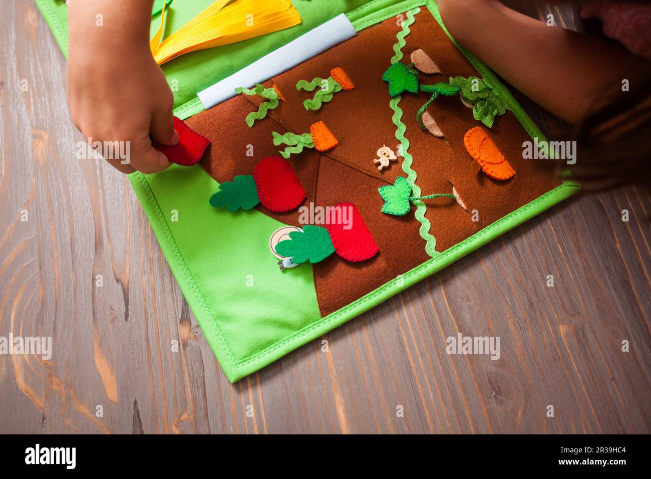 Interesting games with a textile book in kindergarten Stock Photo - Alamy
