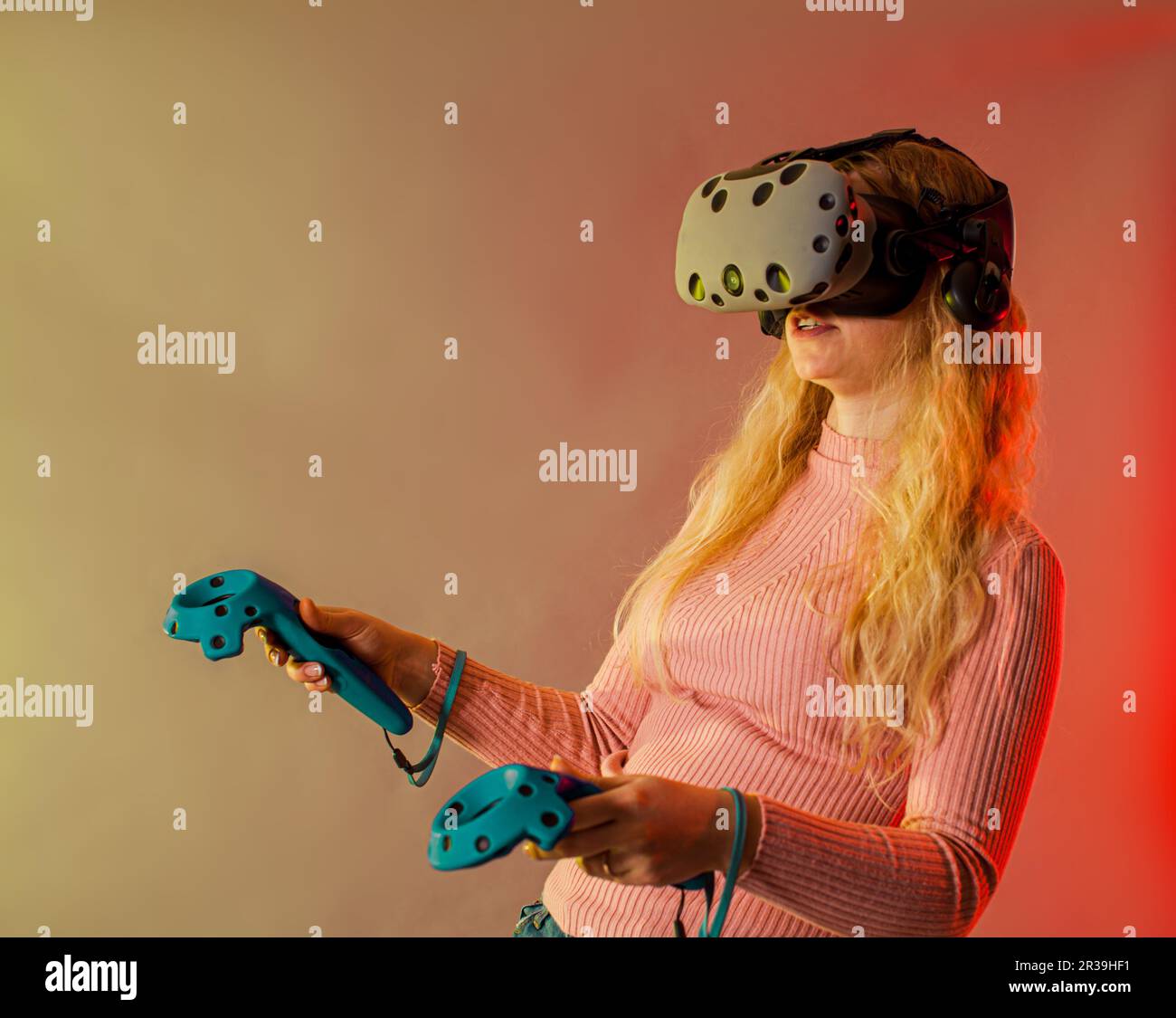 Girl in headset of vr virtual reality play game with joystick Stock ...