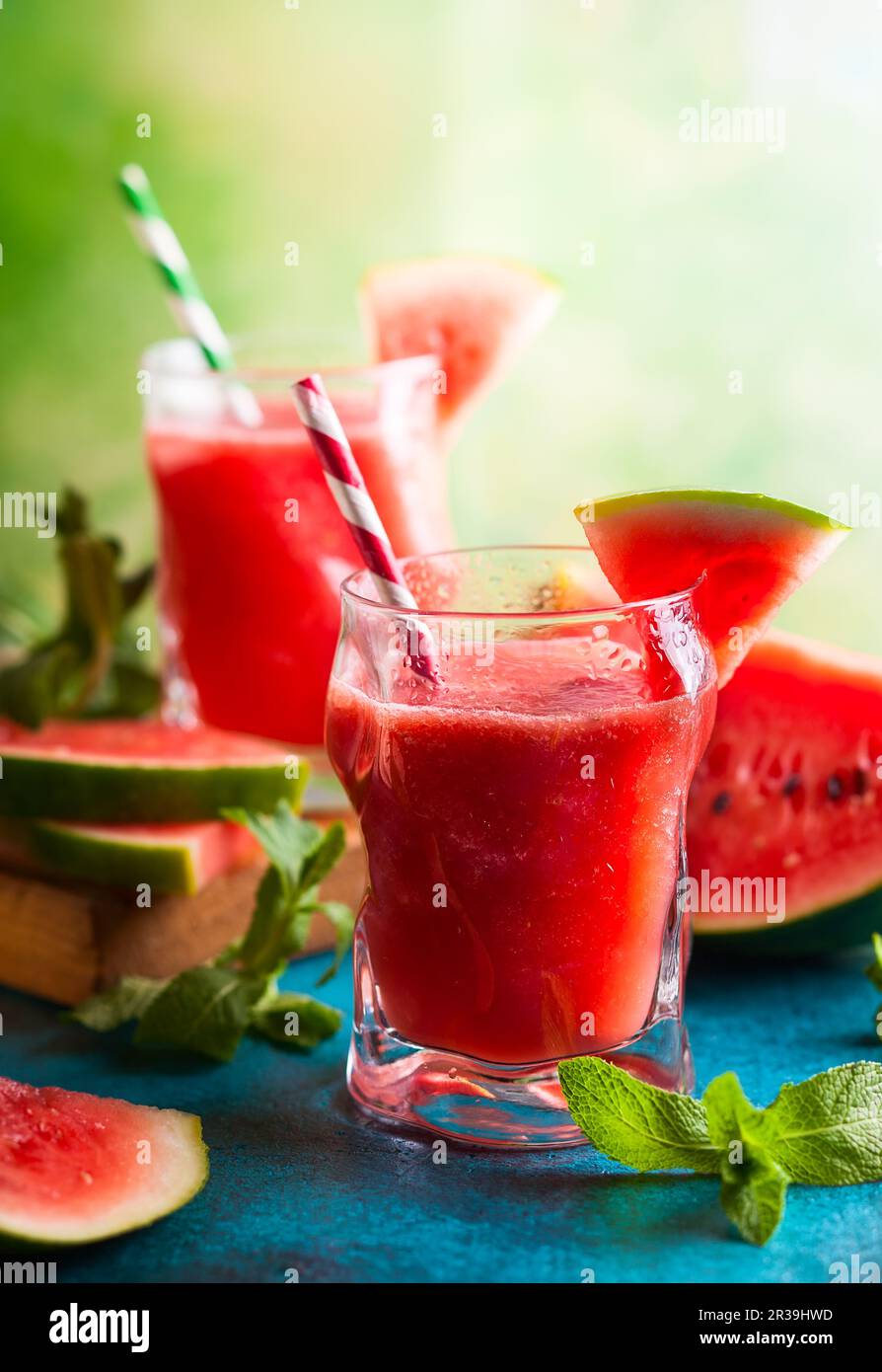 Summer refreshing watermelon drink in glasses with mint and drinking ...