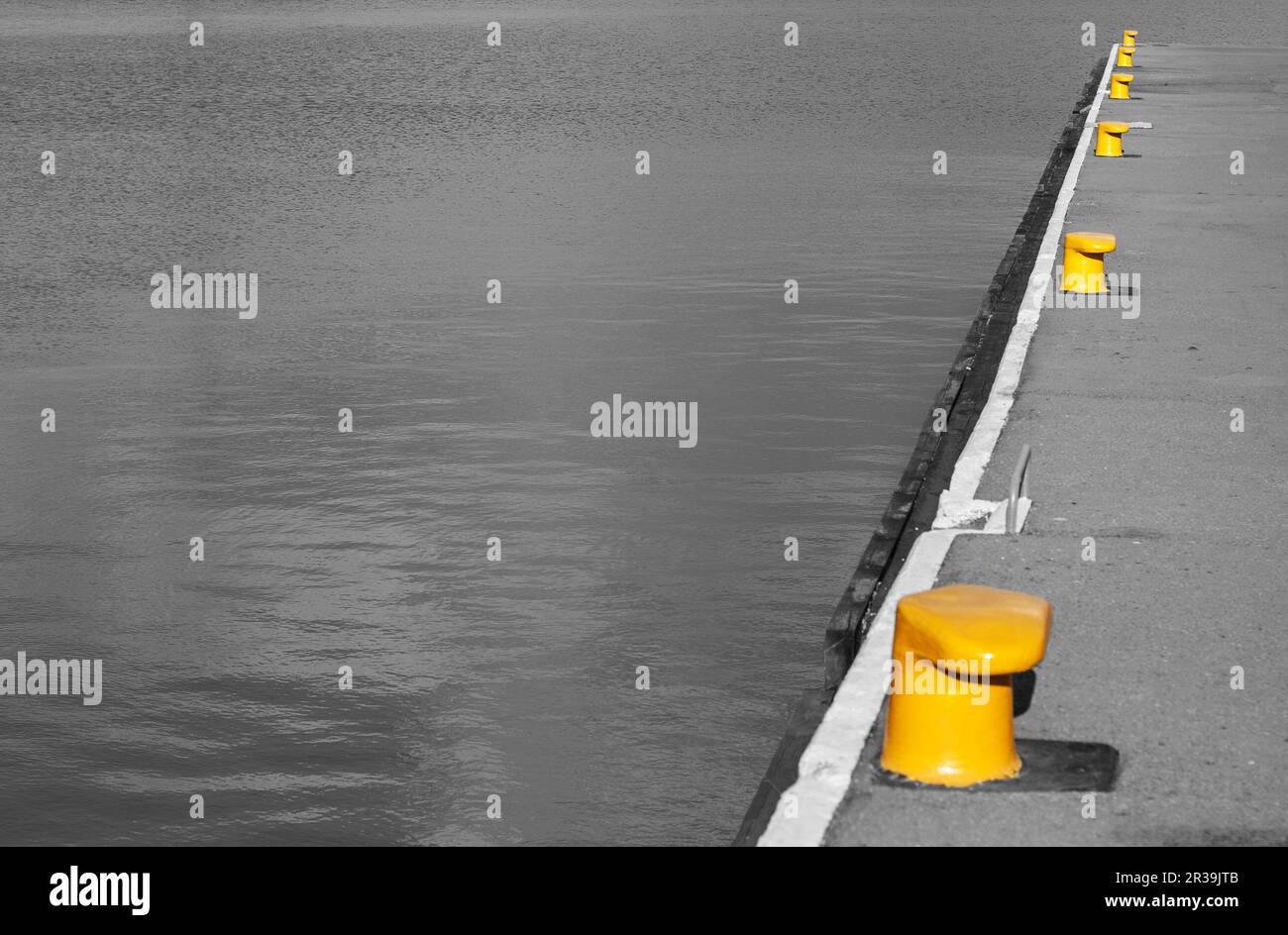 Harbour and quey with mooring posts Stock Photo - Alamy