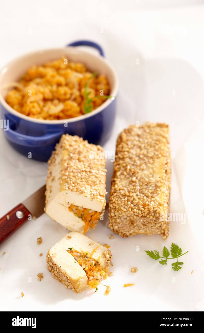 Baked tofu slices in a sesame coating with lentils Stock Photo - Alamy