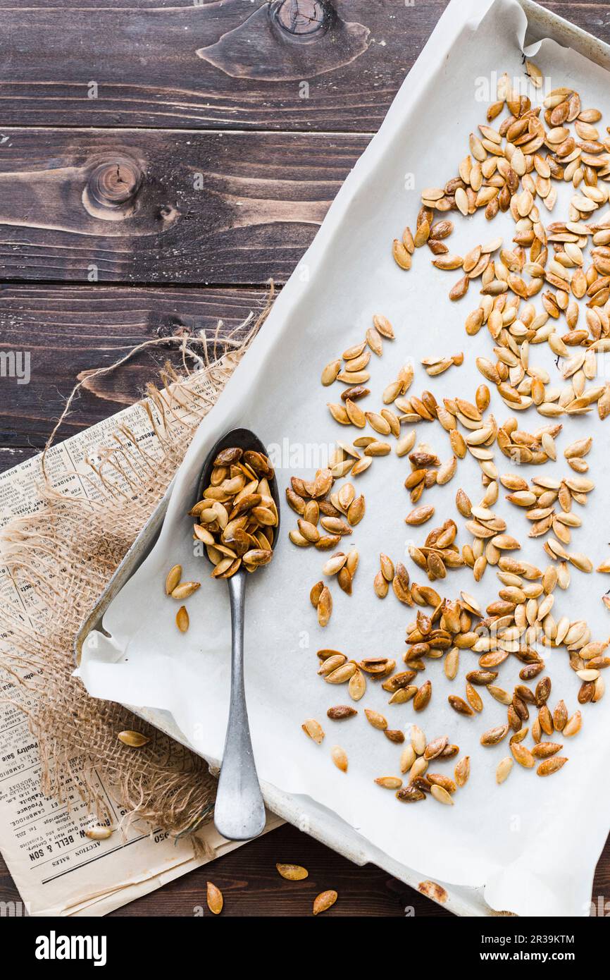 Roasted pumpkin seeds on baking paper Stock Photo - Alamy