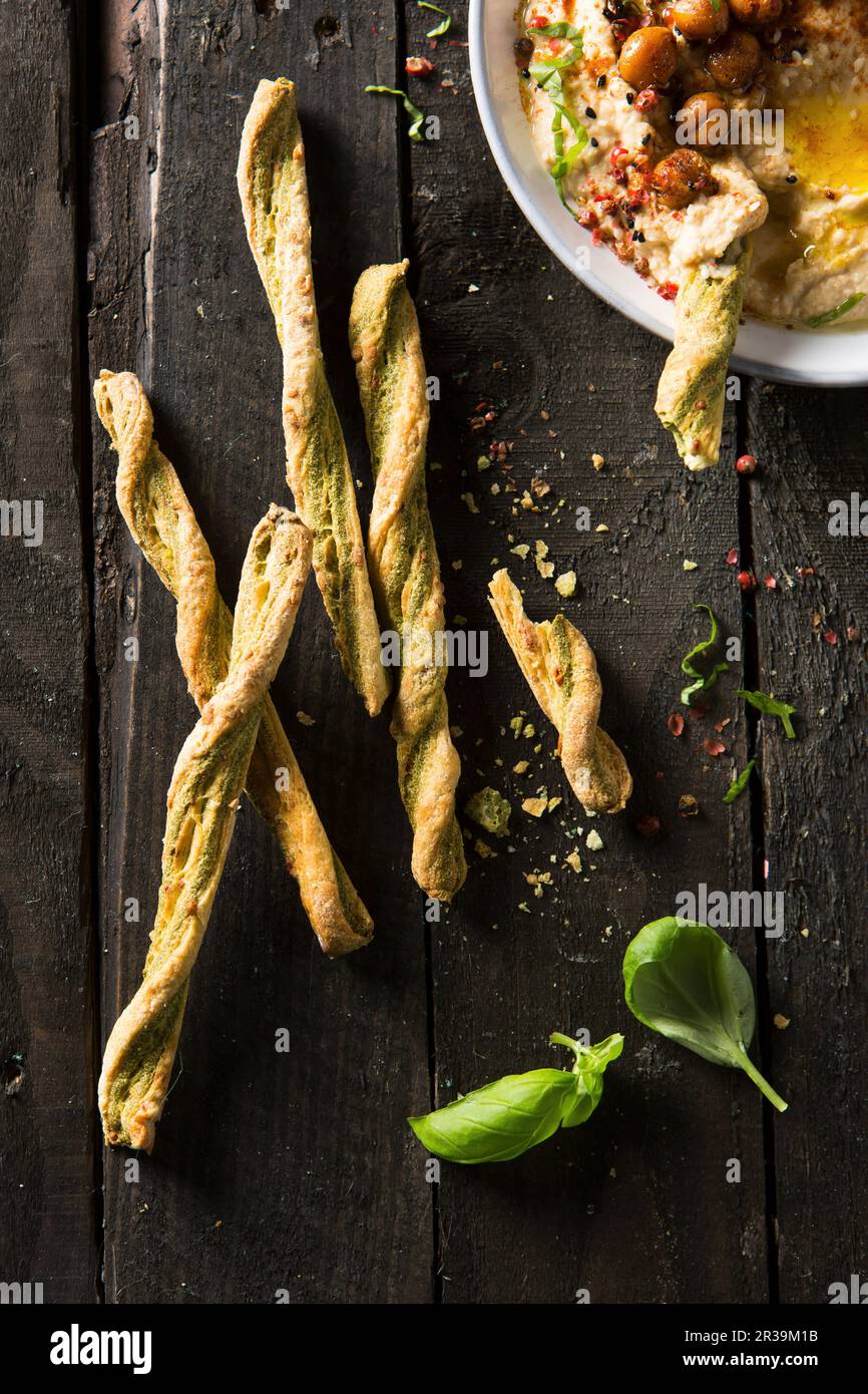 Basil and parmesan breadsticks with hummus dip Stock Photo - Alamy