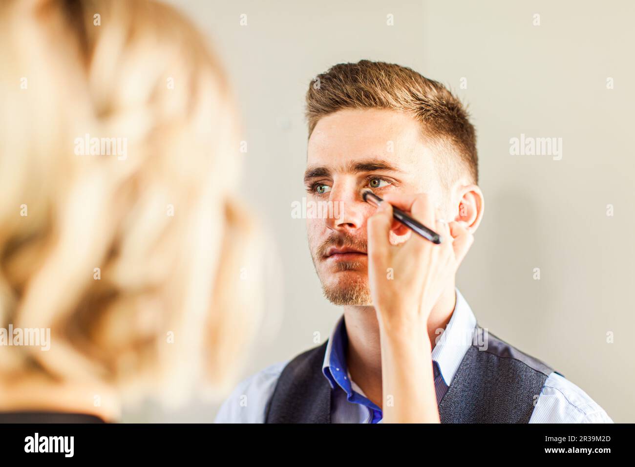 Handsome man doing makeup for fashion photography studio Stock Photo ...